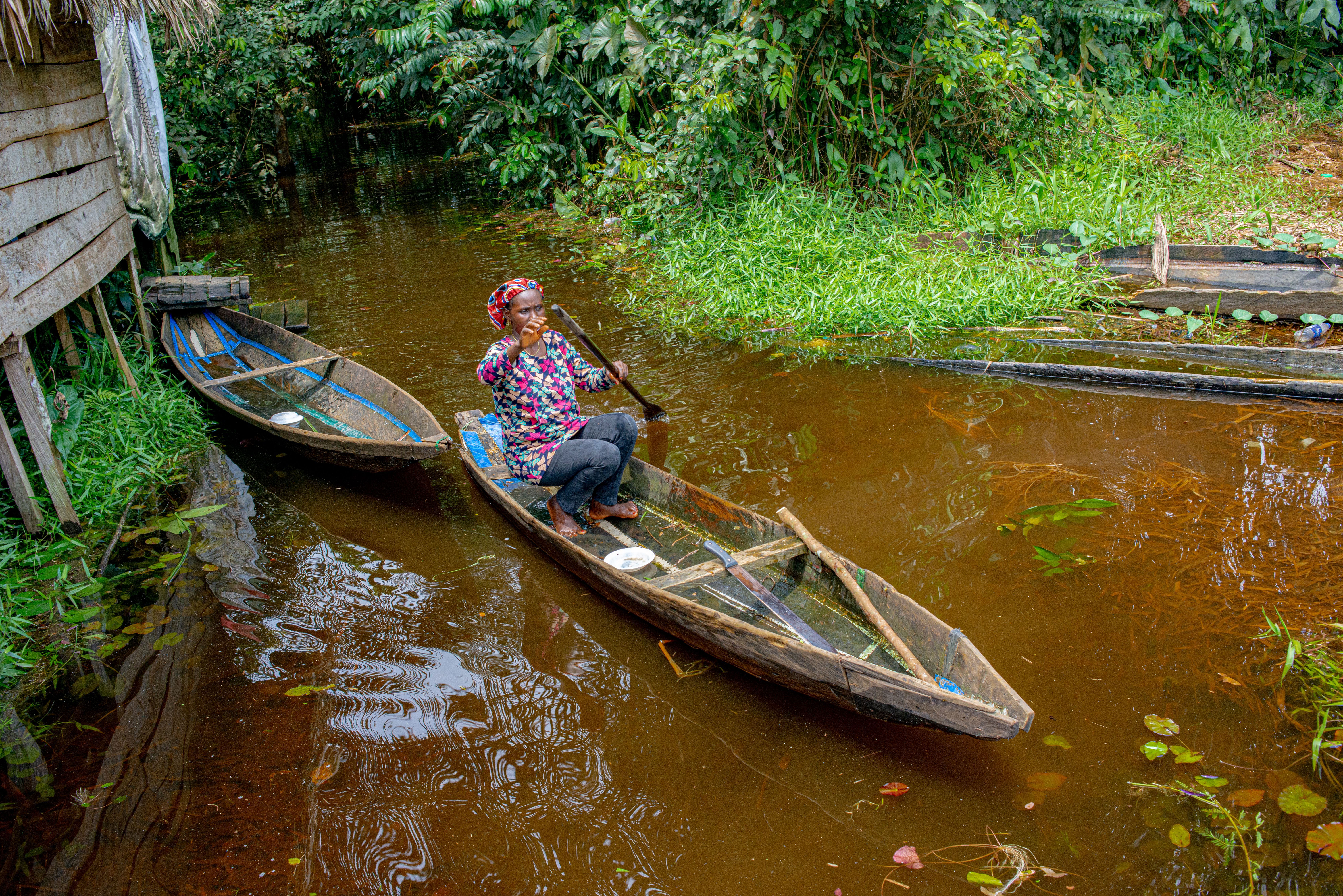 A Woman Paddling a Boat on a River · Free Stock Photo