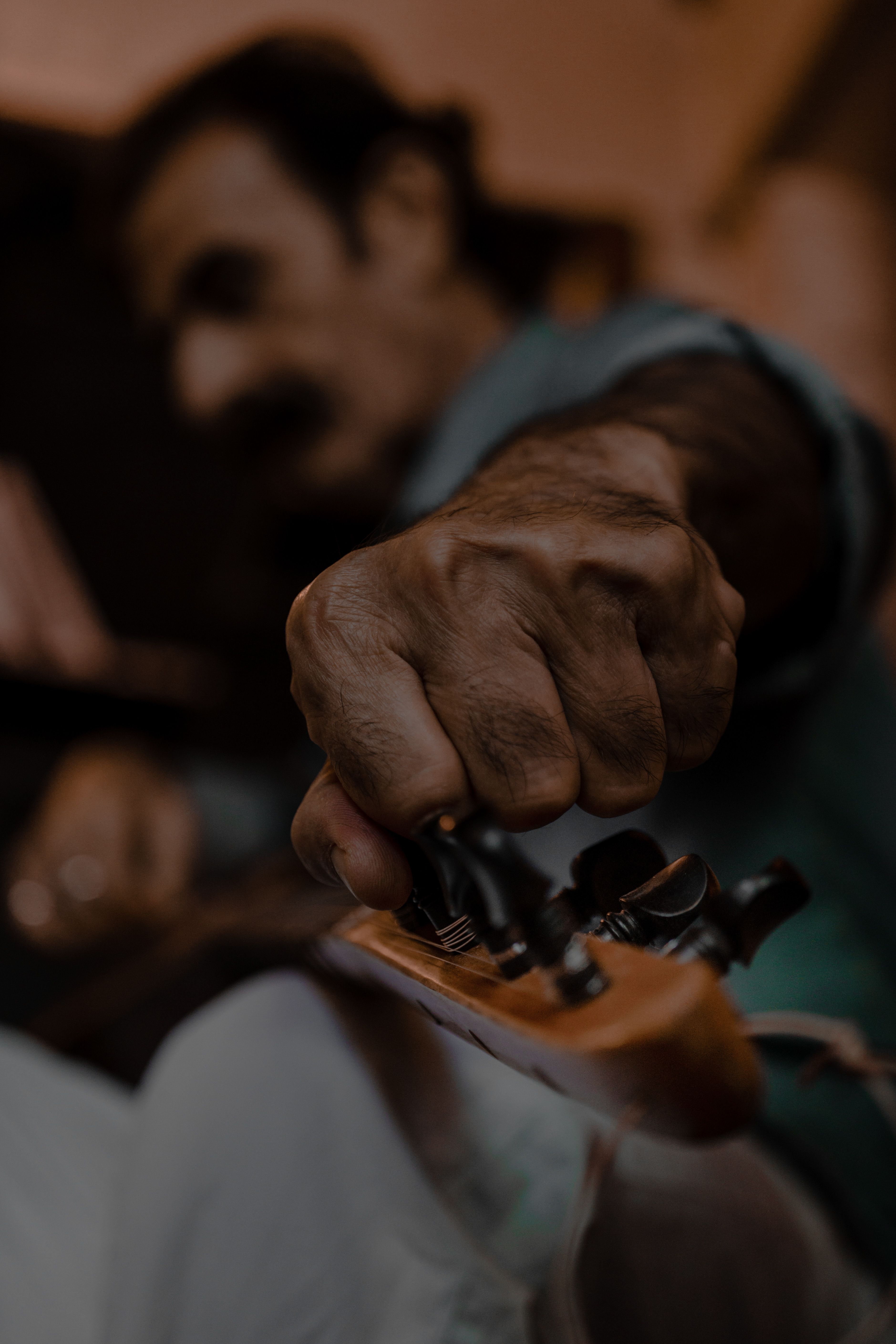 Man Tuning Guitar · Free Stock Photo