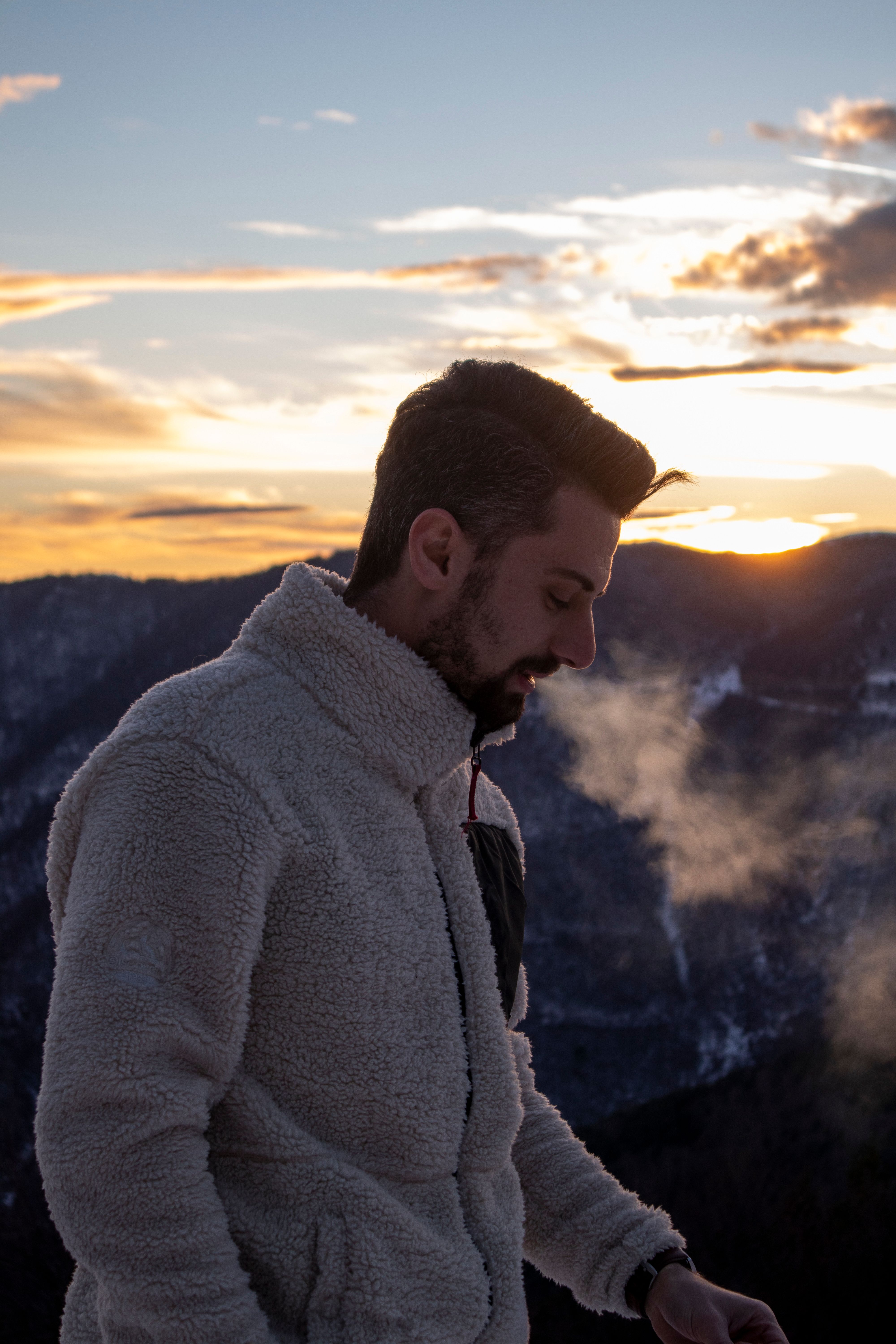 A Man Standing Outdoors at Sunset · Free Stock Photo