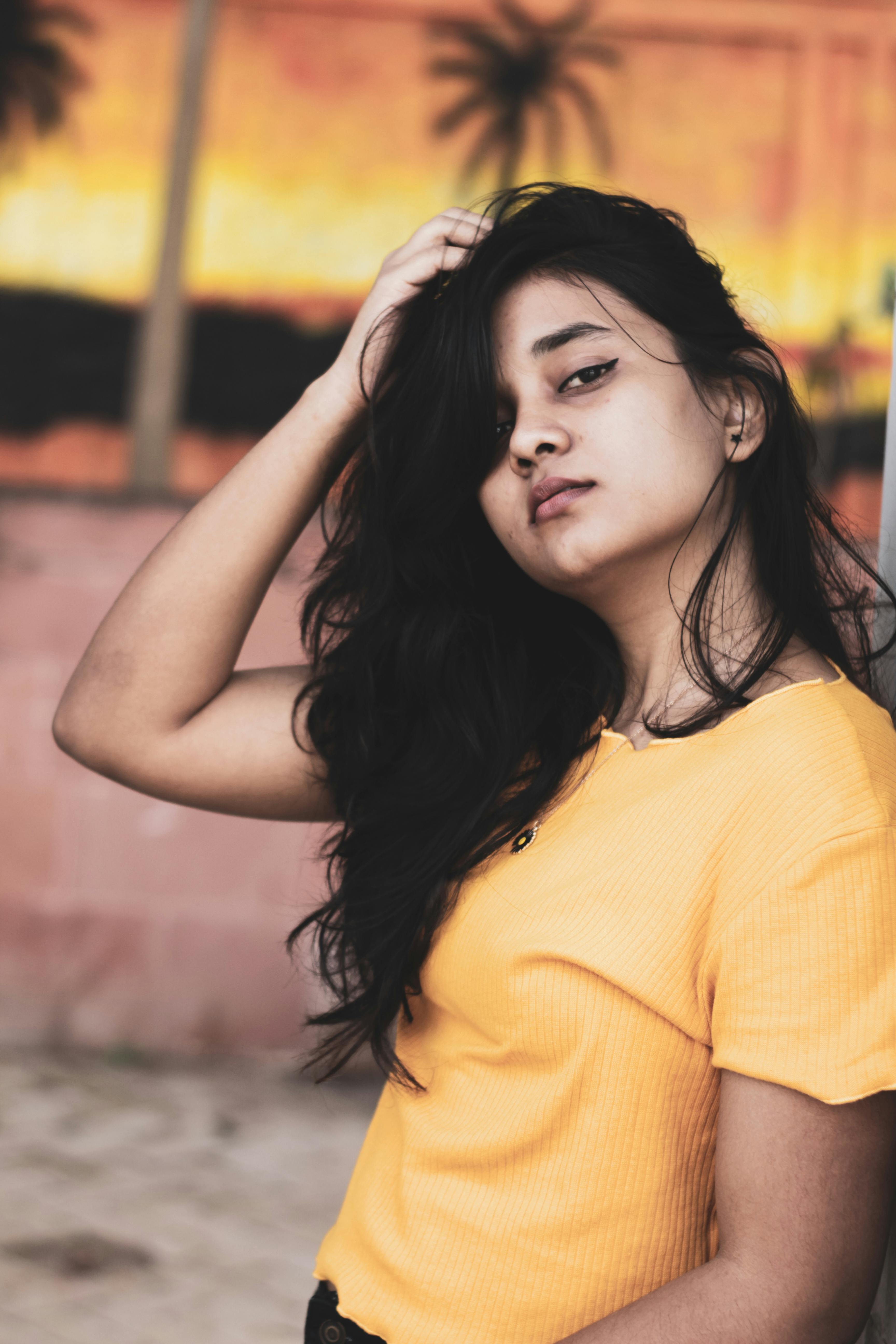 Side View of a Girl Touching Her Hair · Free Stock Photo