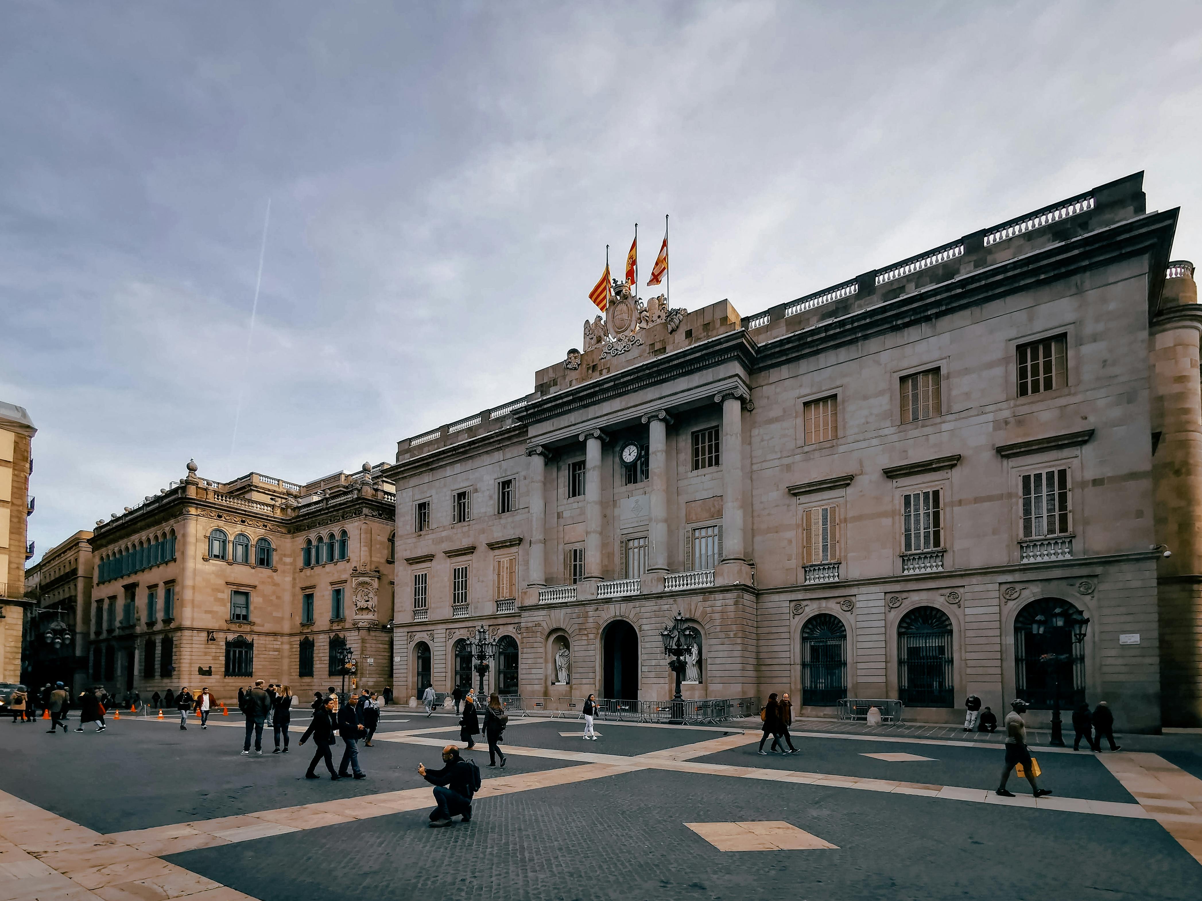 People Walking near Ornamented Building with Columns · Free Stock Photo