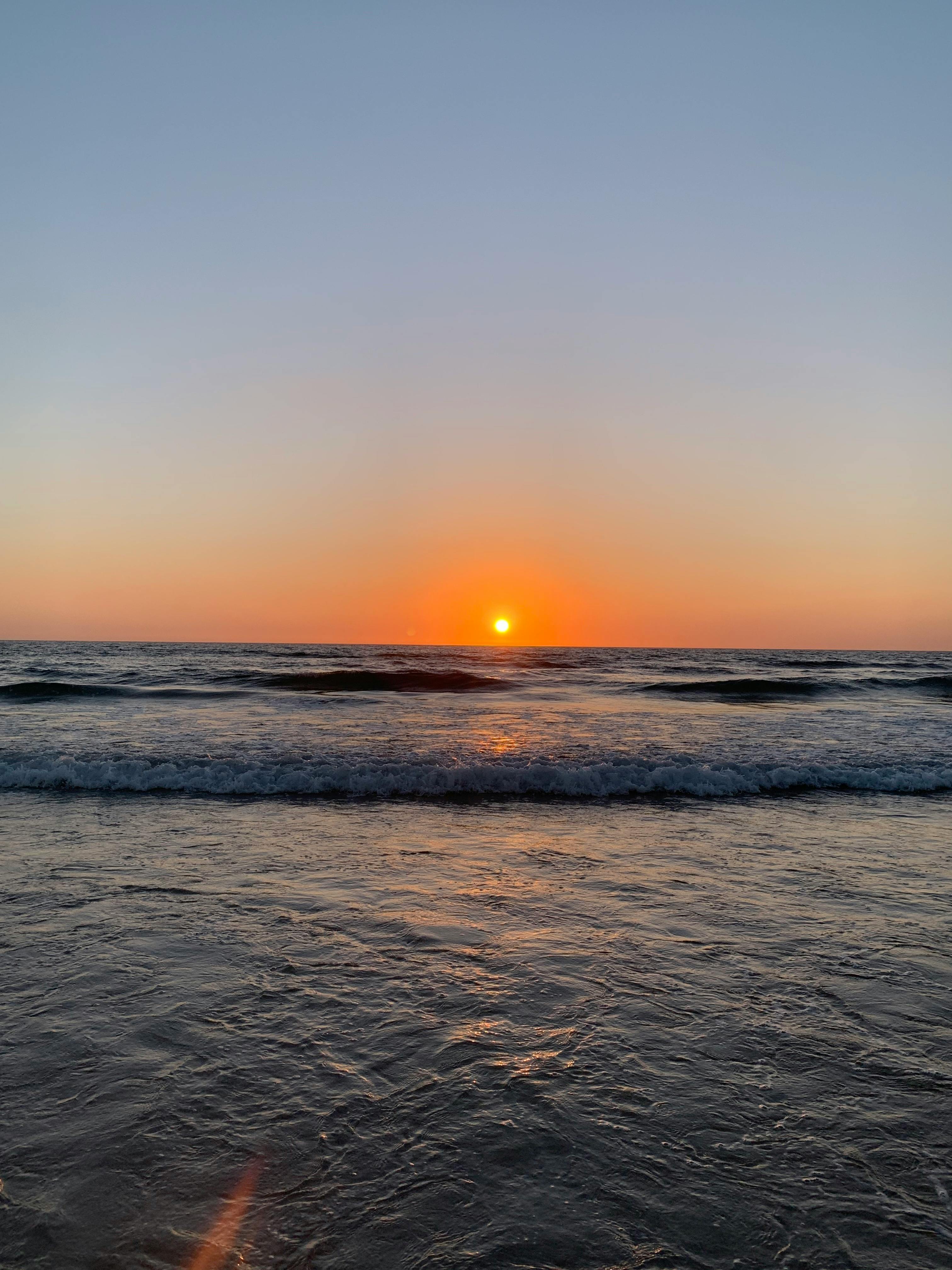 Sun Setting on Horizon above Sea · Free Stock Photo