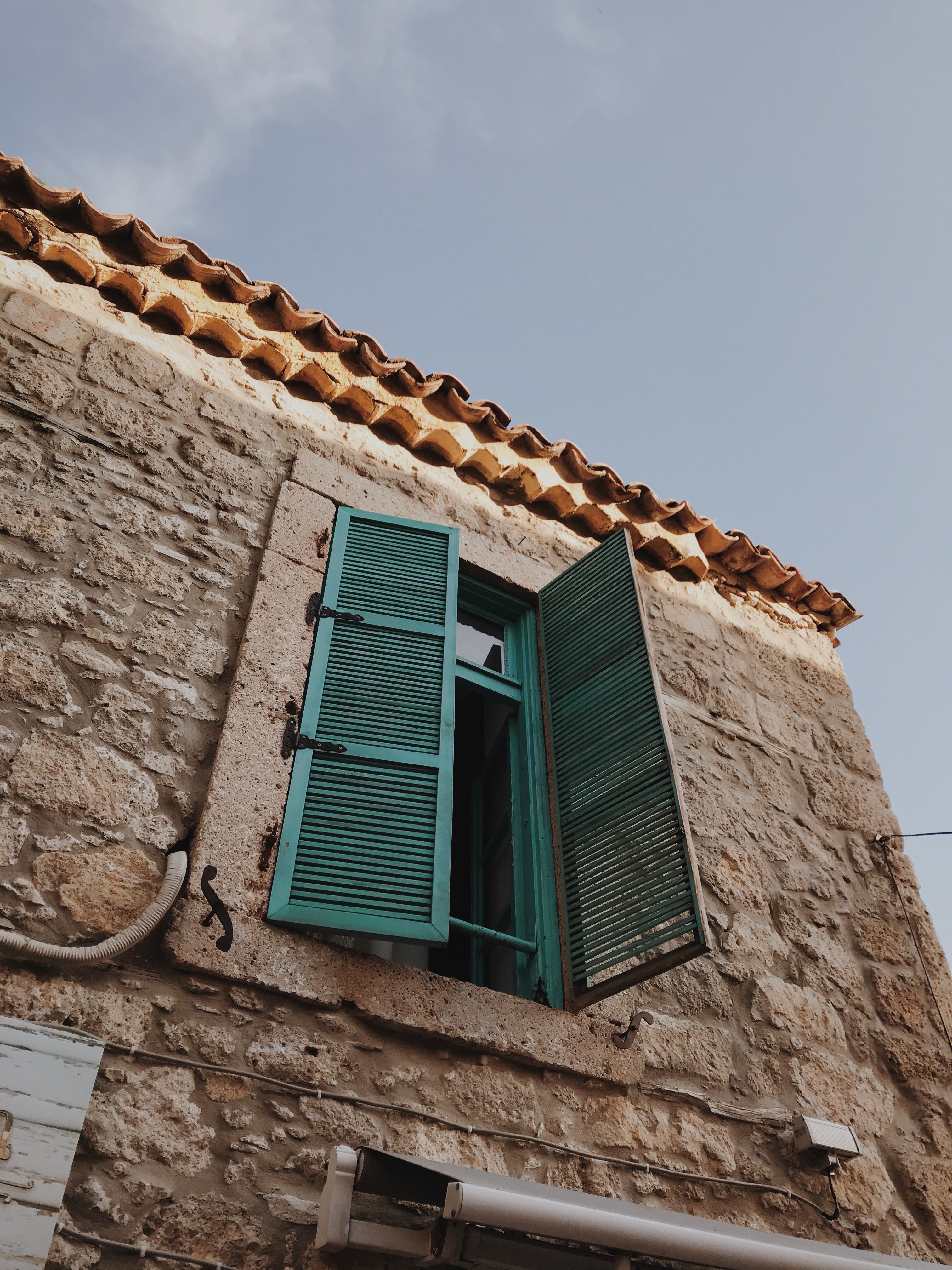 Shutters on Stone Building Wall · Free Stock Photo