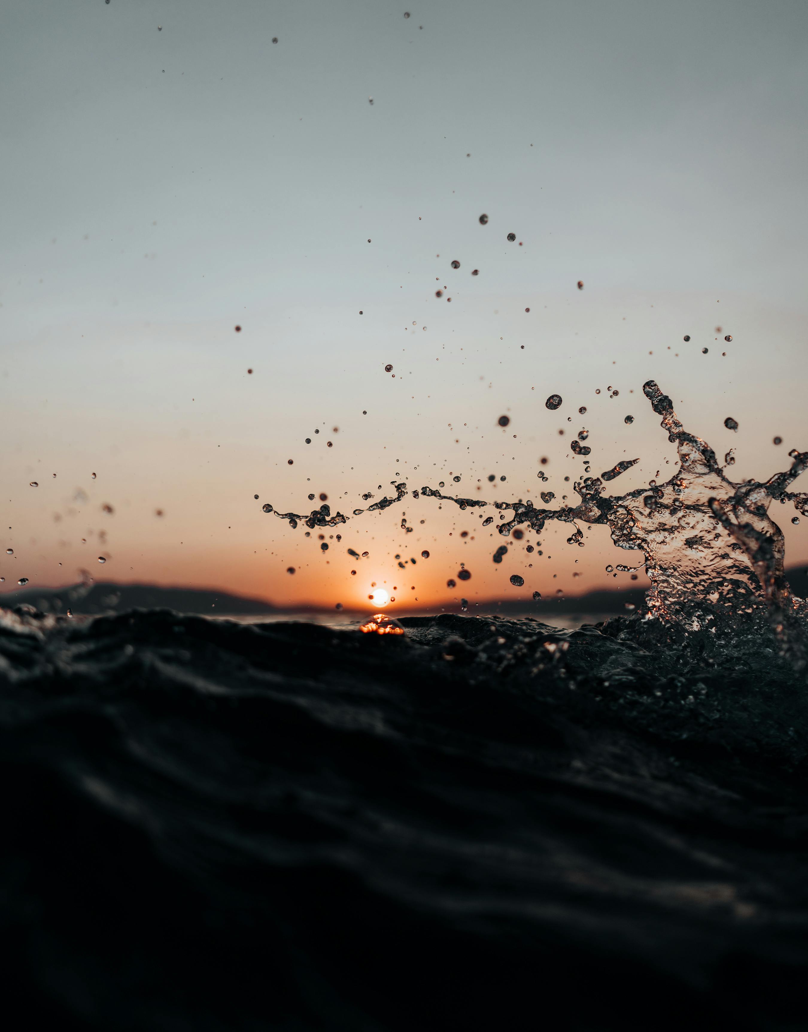 Close-up of Splashing Water in the Sea on the Background of a Sunset ...