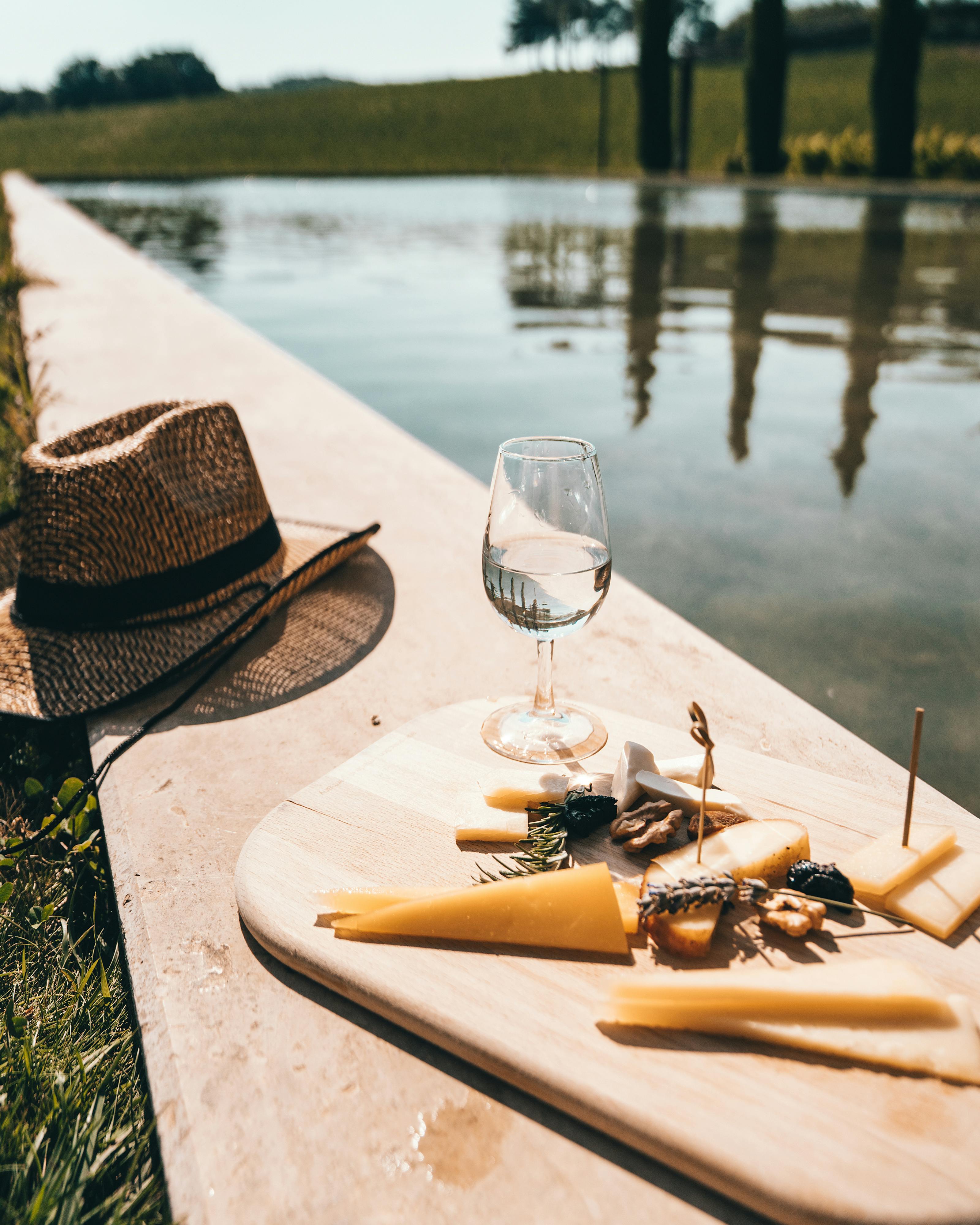 Water and Snack on Tray on Wall by River · Free Stock Photo