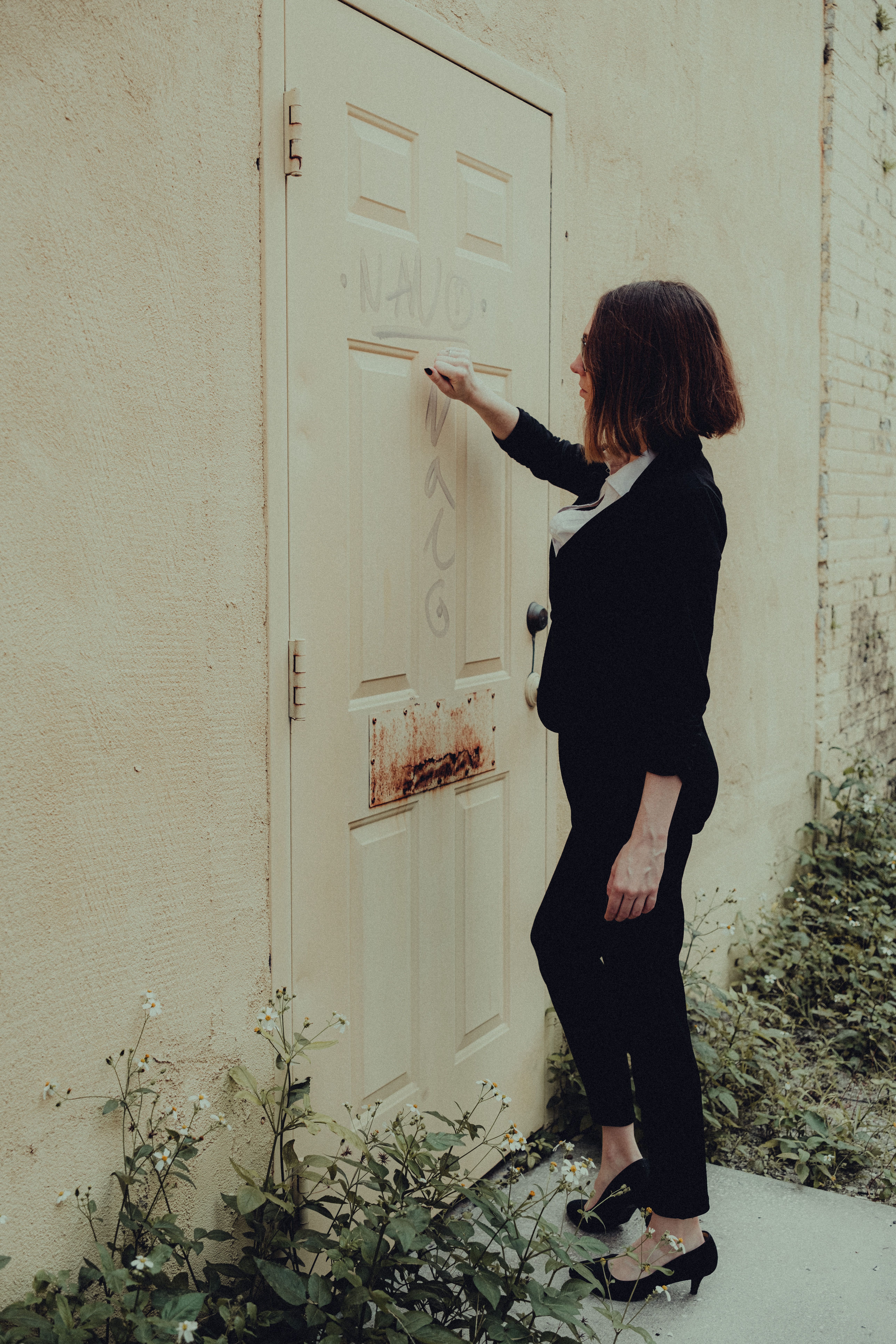 Woman in Black Suit Knocking at Door · Free Stock Photo