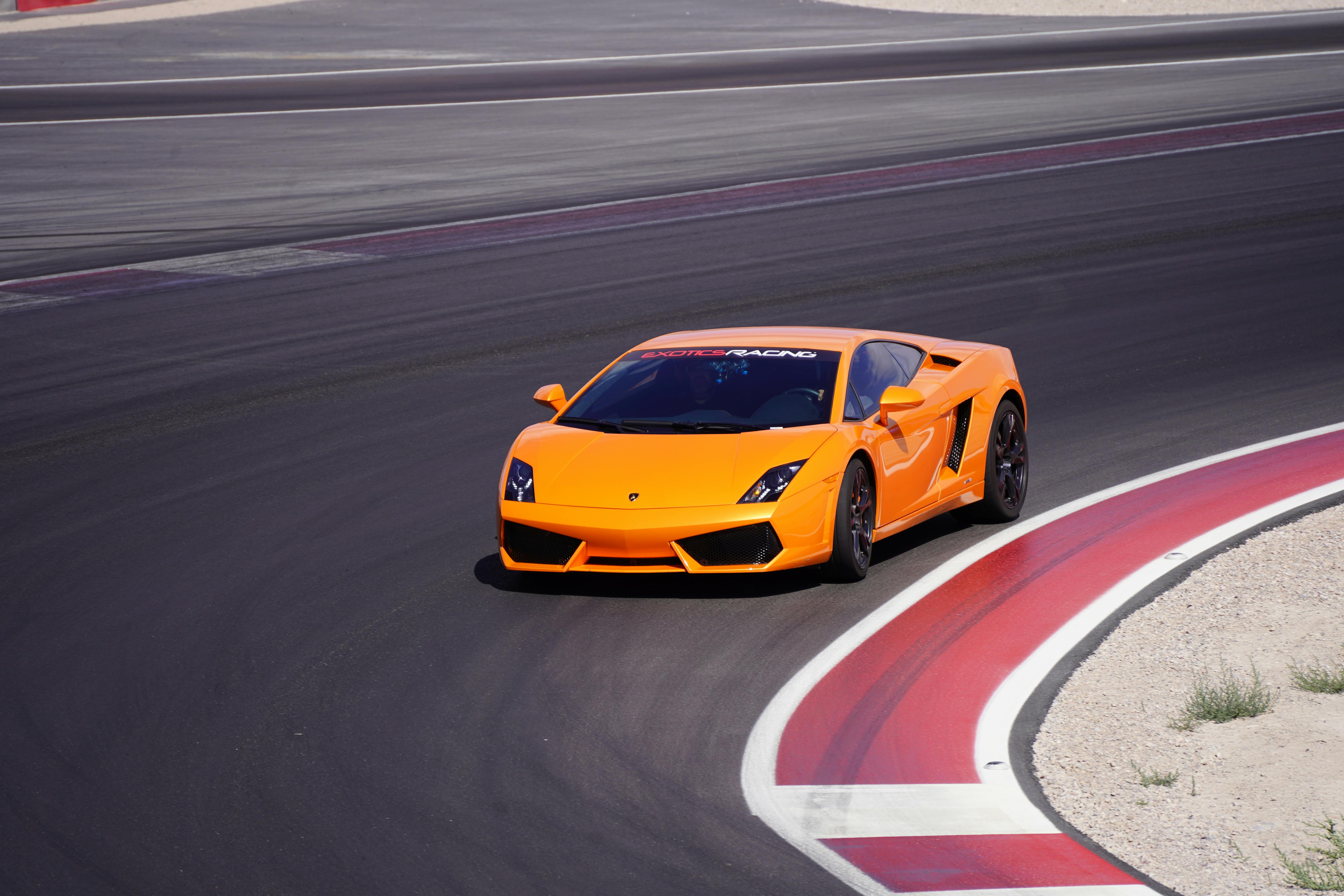 Orange Racing Car on Track · Free Stock Photo