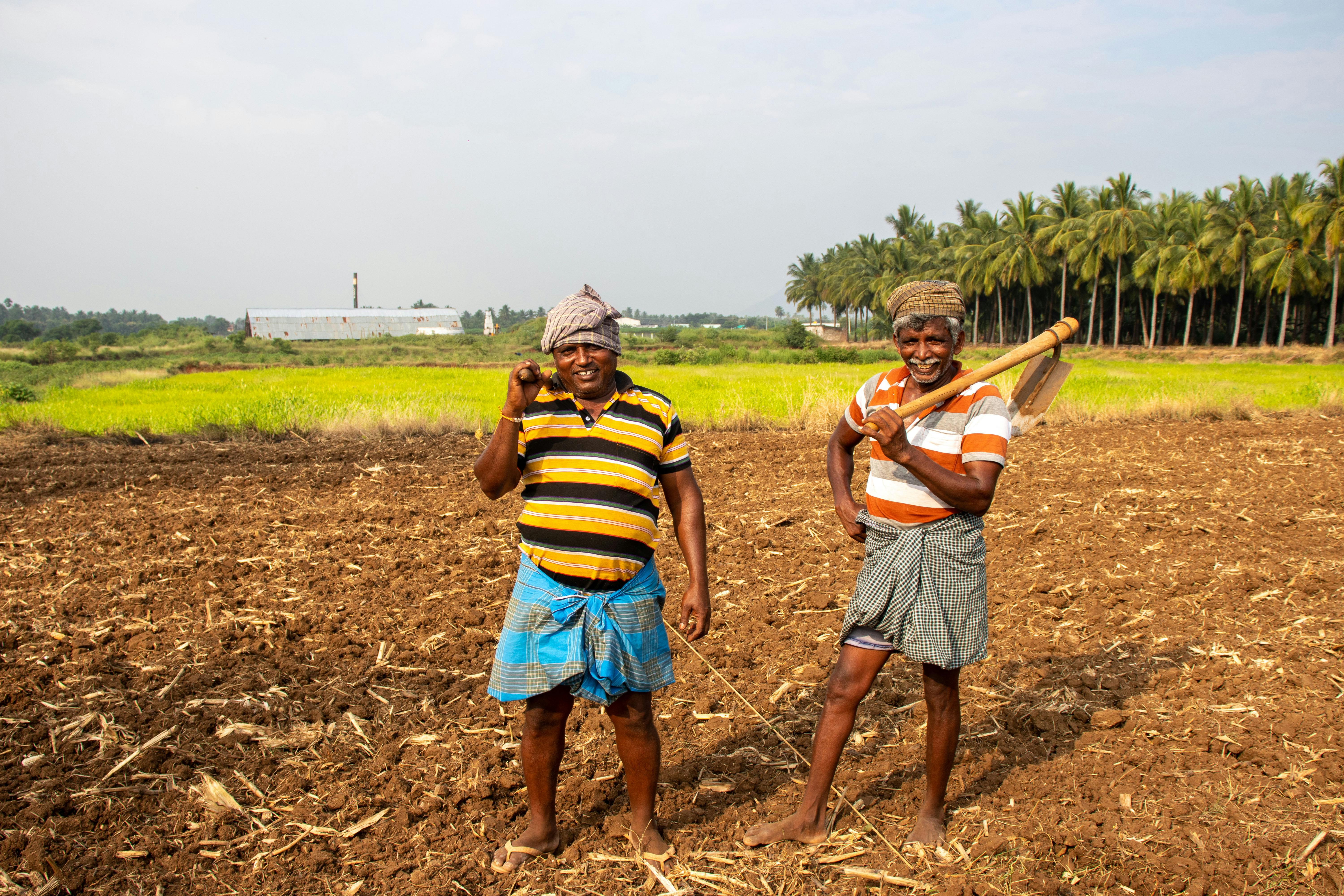 Smiling Farmers in Field · Free Stock Photo