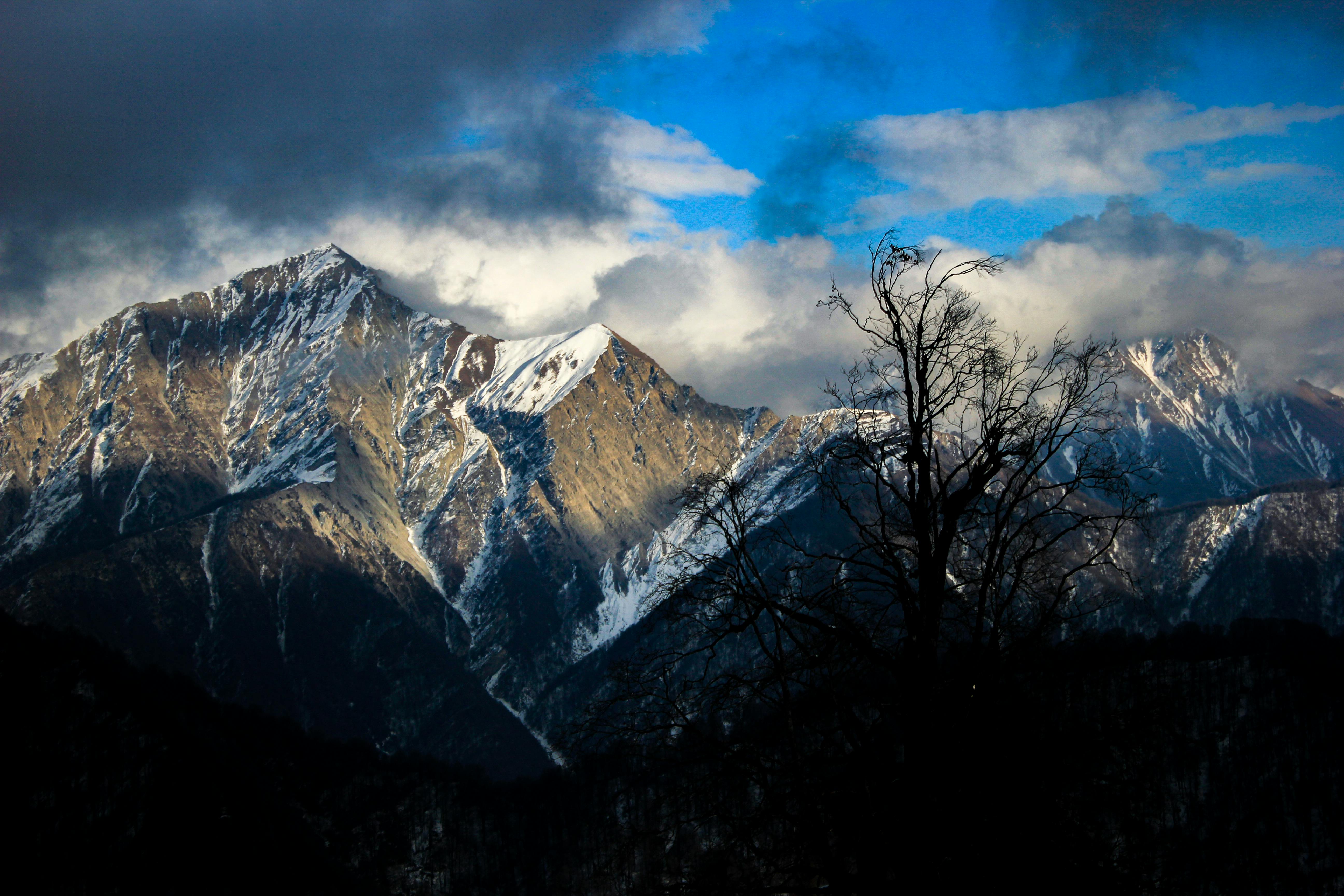 Gray Rocky Mountain in Front of Sand Field · Free Stock Photo