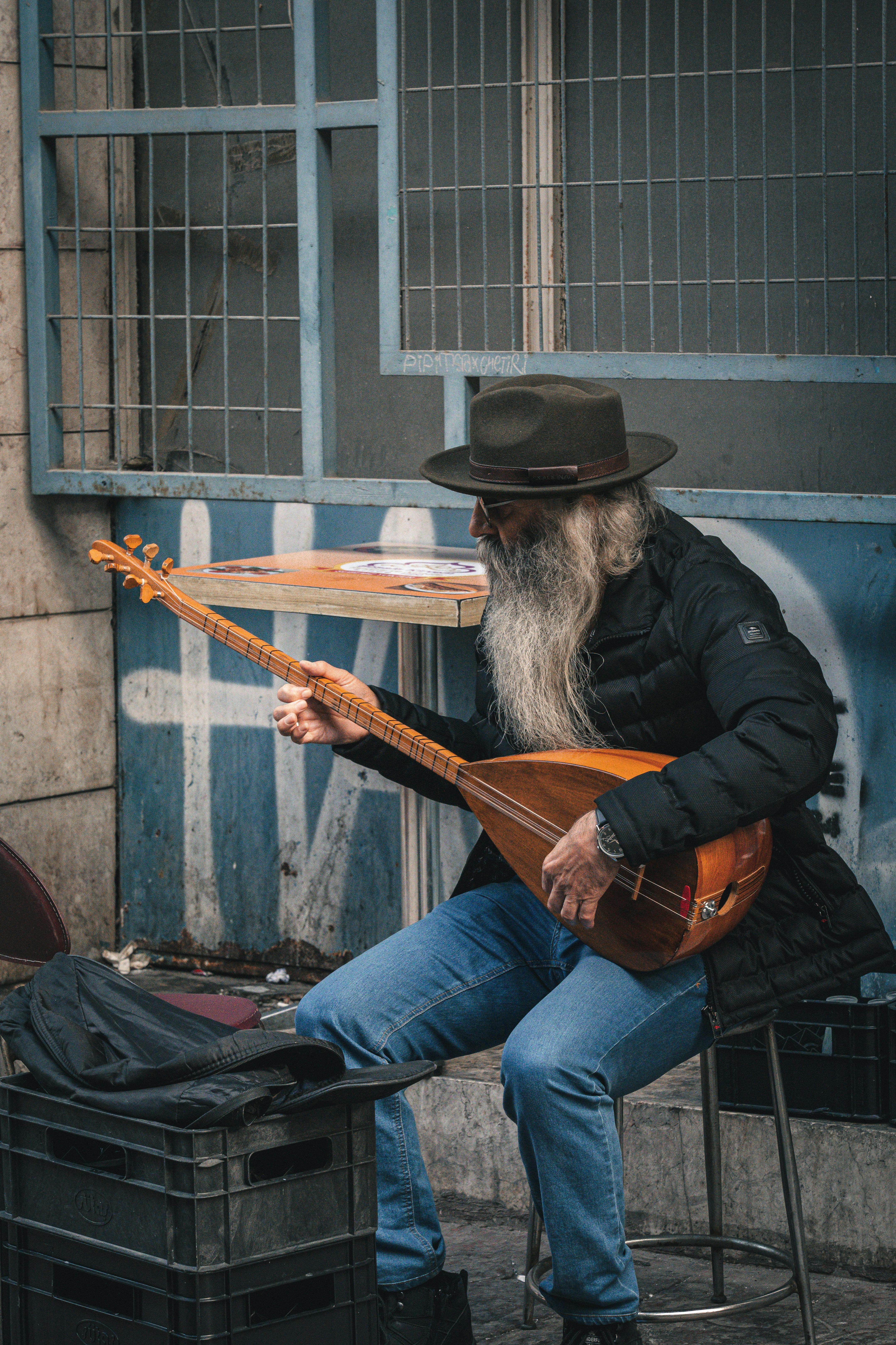 A Man Playing a Musical Instrument in a City · Free Stock Photo
