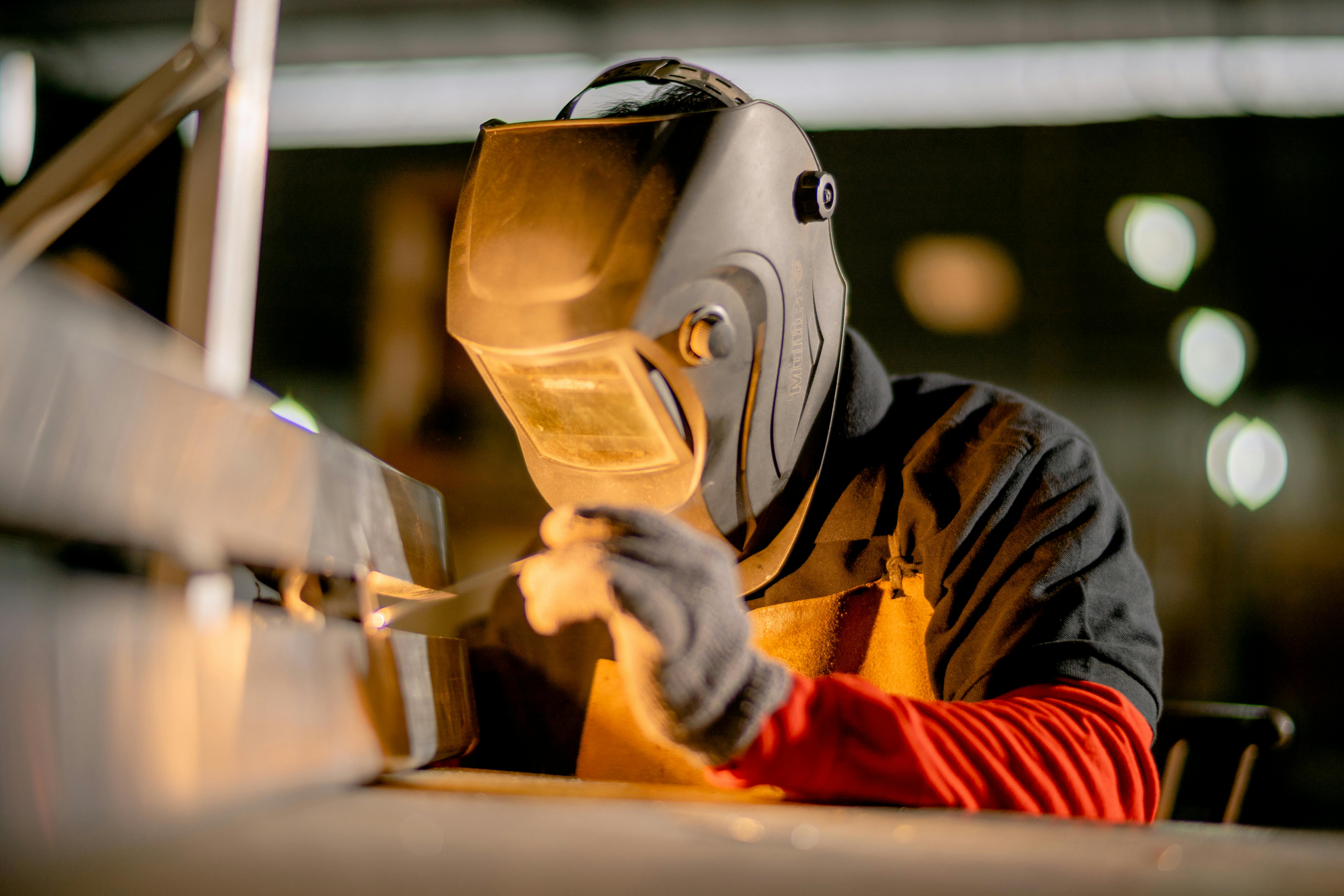 A Person Welding at a Workshop · Free Stock Photo