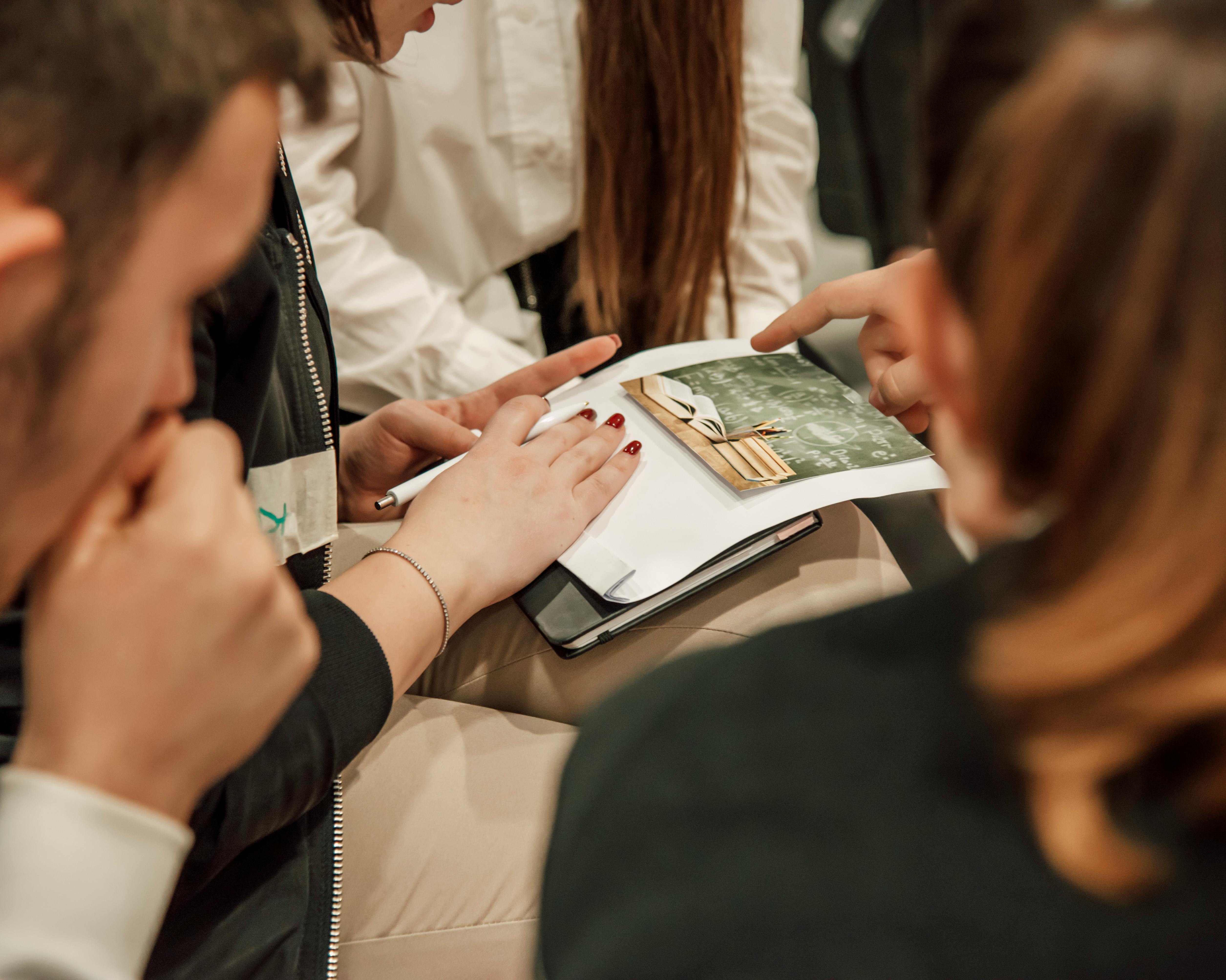 People Cooperate Around Book · Free Stock Photo