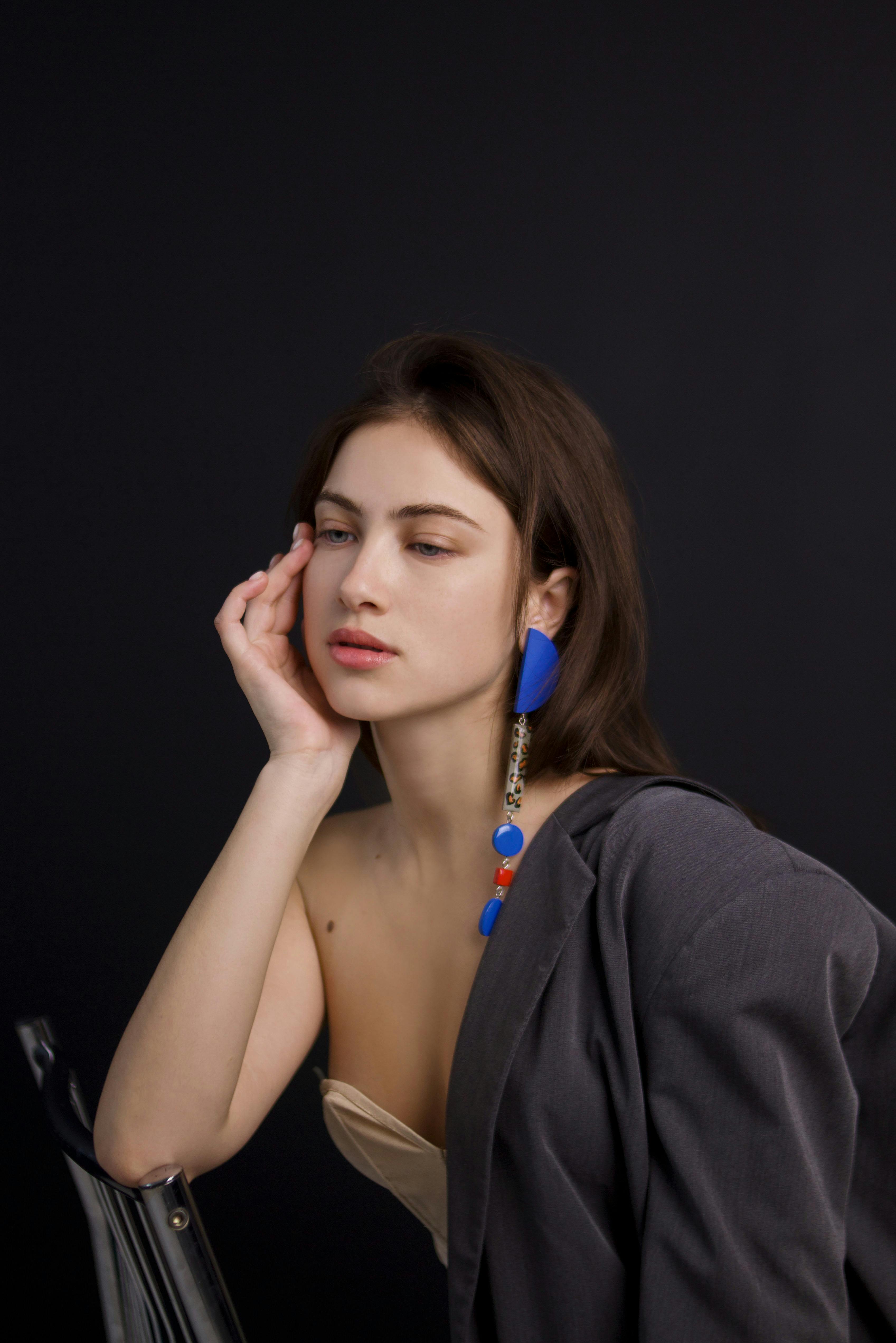 Pretty Woman Posing with Hand on Her Cheek · Free Stock Photo