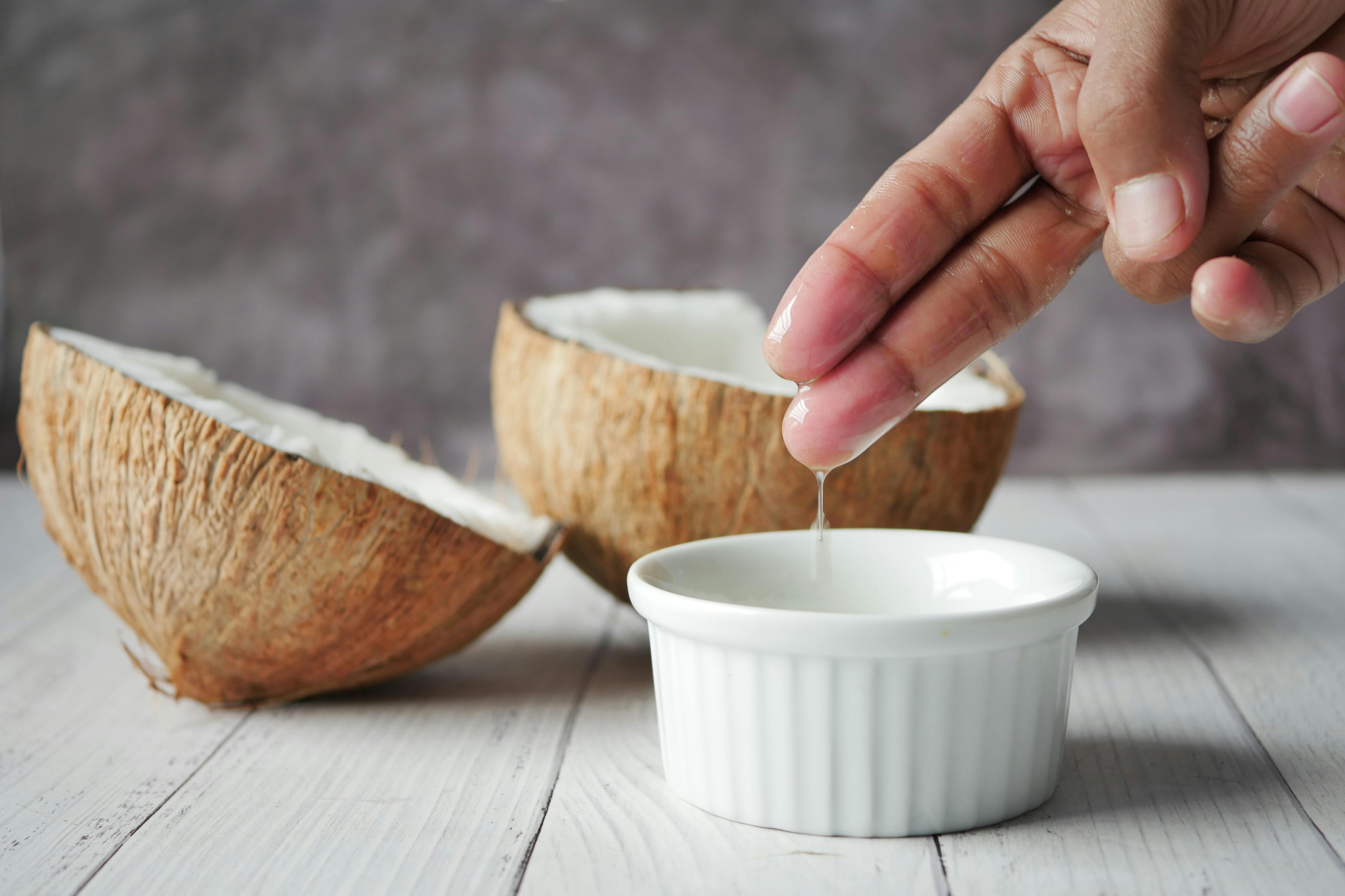 Photo Of Woman Cracking Coconut Shells · Free Stock Photo
