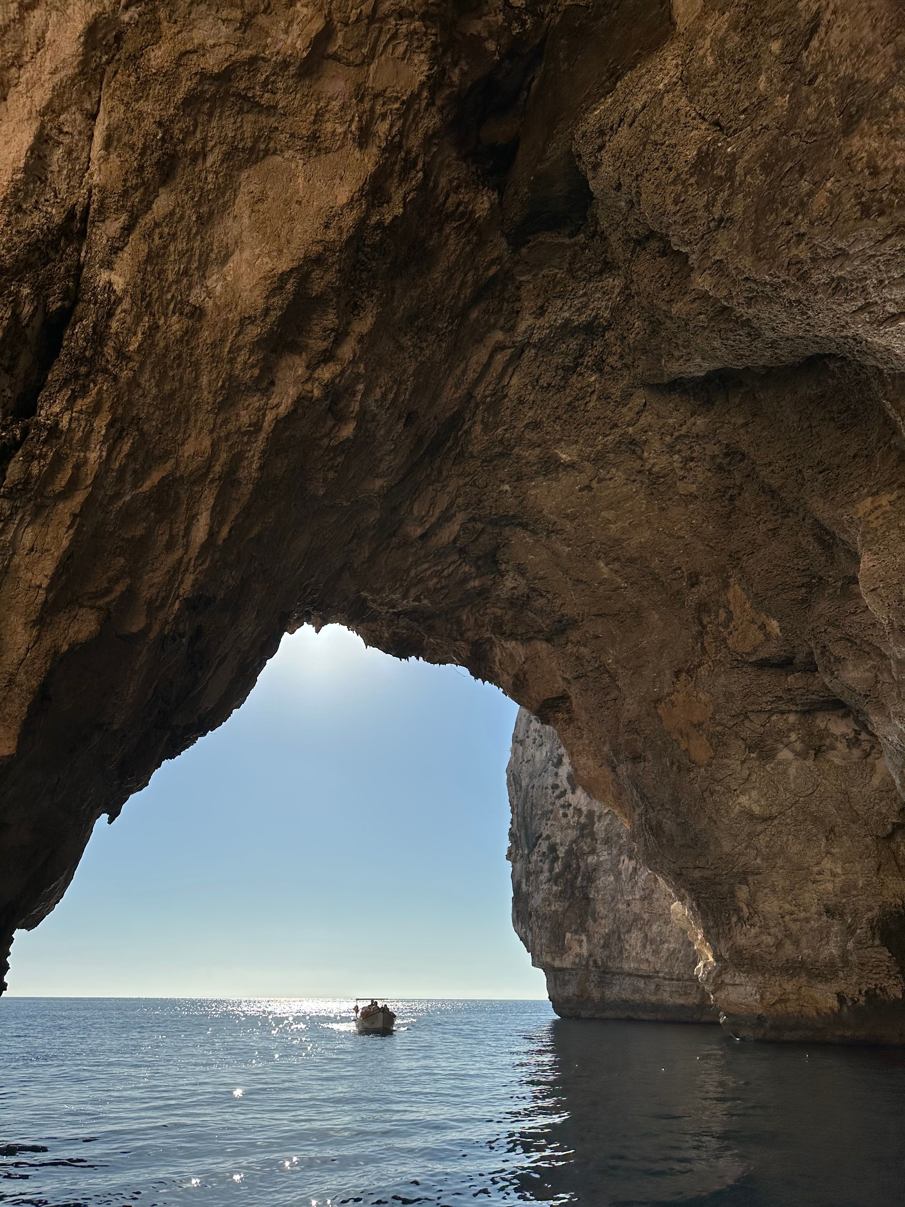 Boat Sailing in Sea near Cliff · Free Stock Photo