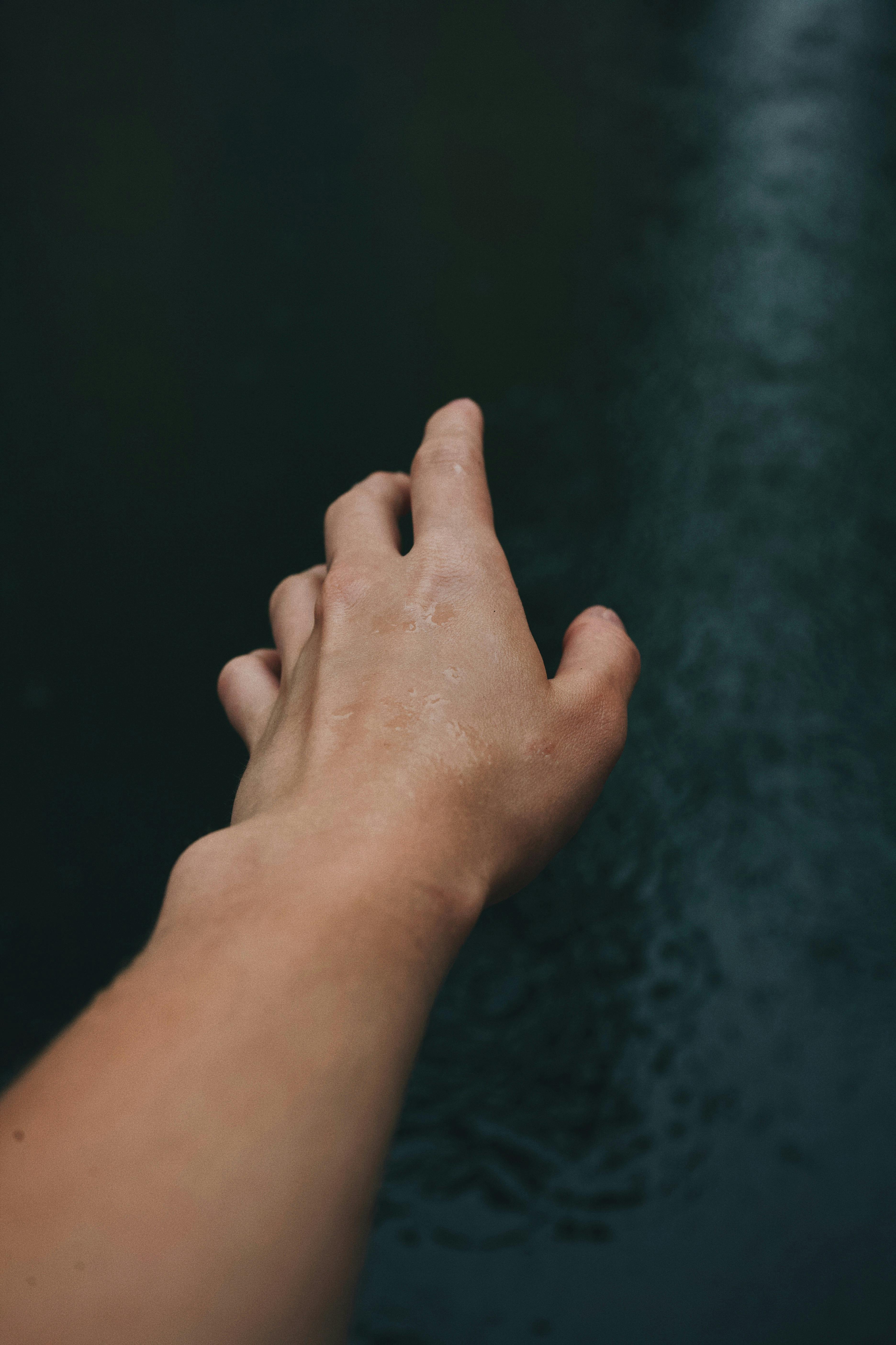 Person's Hand Reaching Out · Free Stock Photo