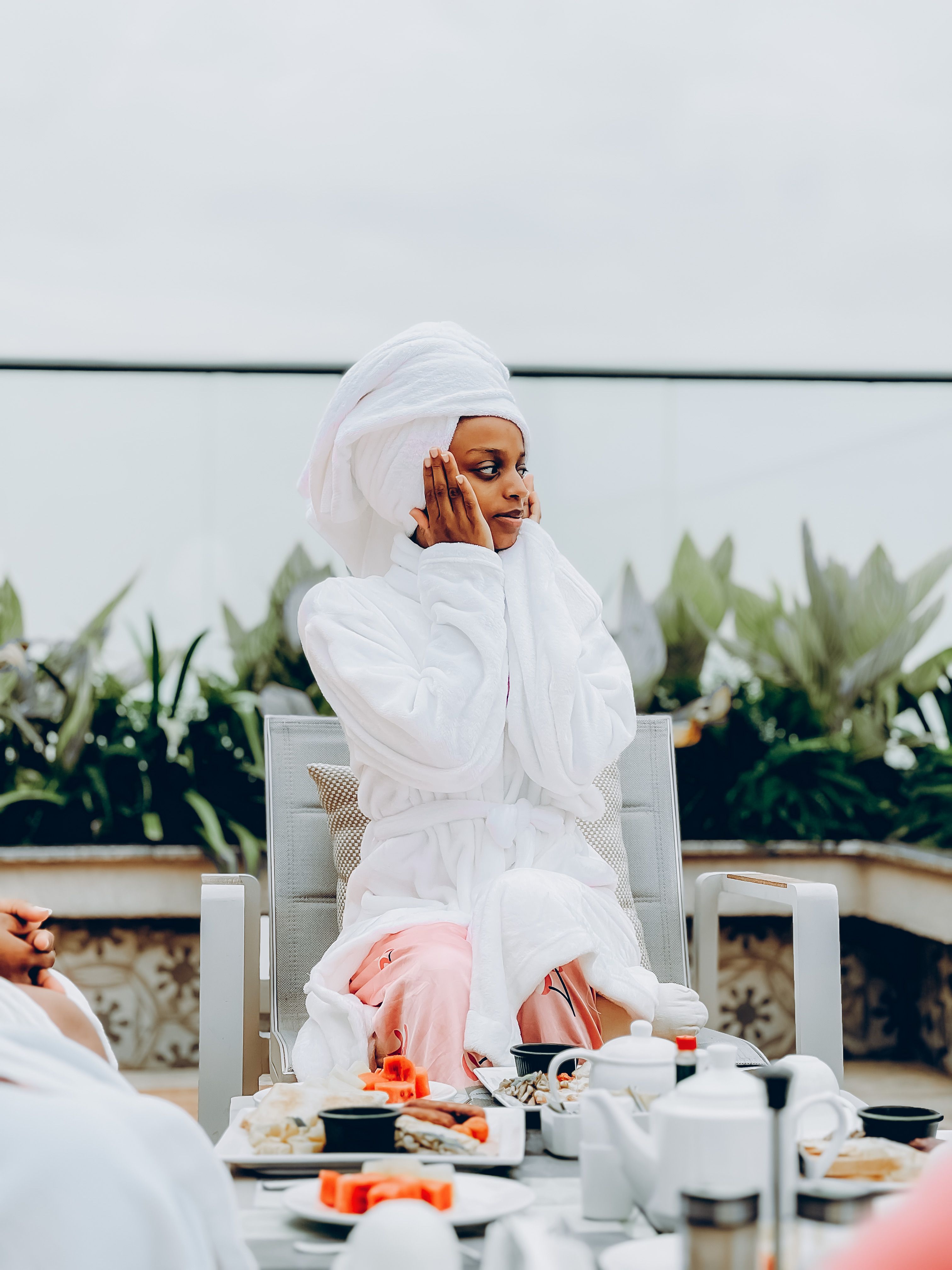 Woman in Bathrobe Sitting at Breakfast Table · Free Stock Photo