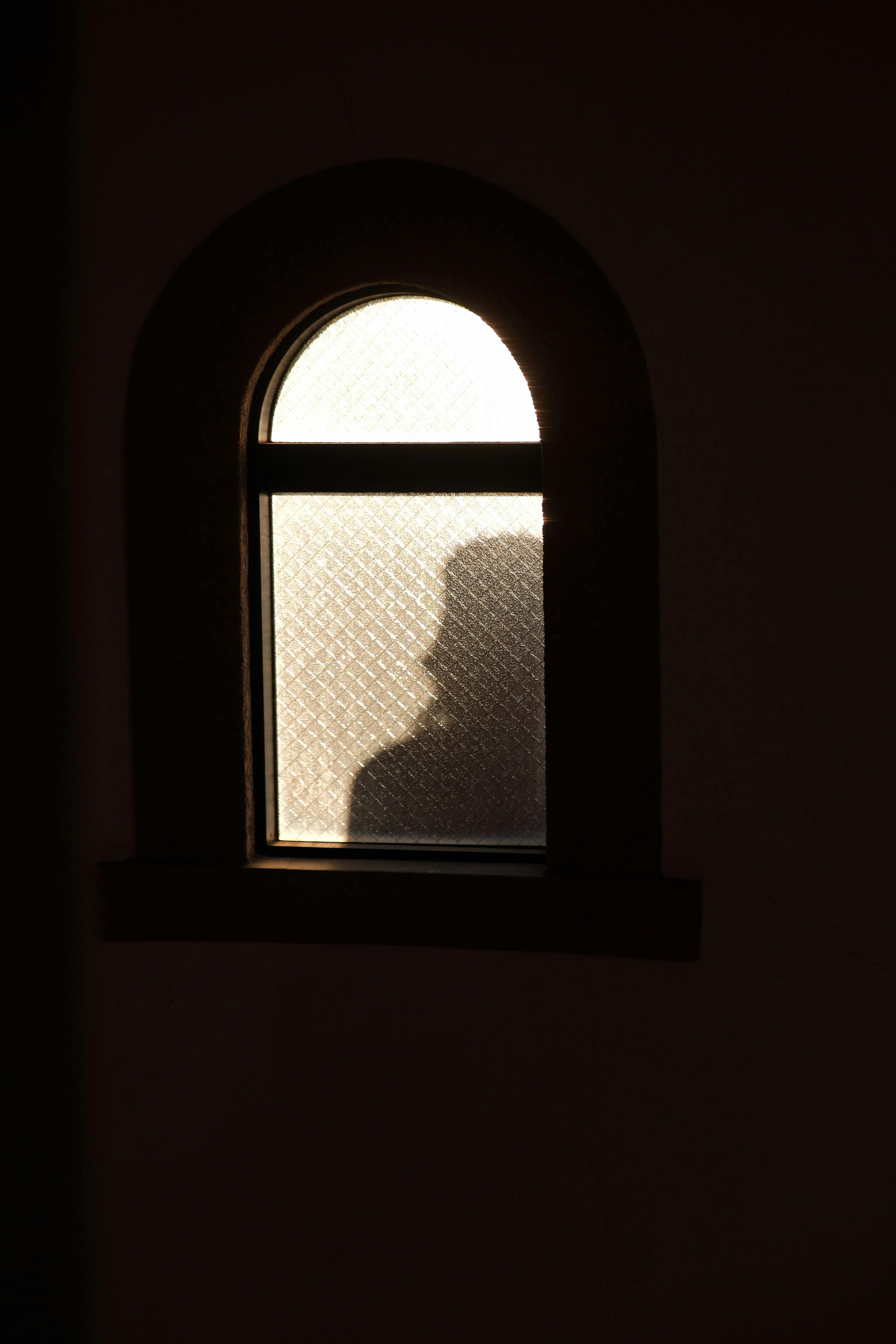 A Person Standing Behind Wooden Window with Stained Glass · Free Stock ...