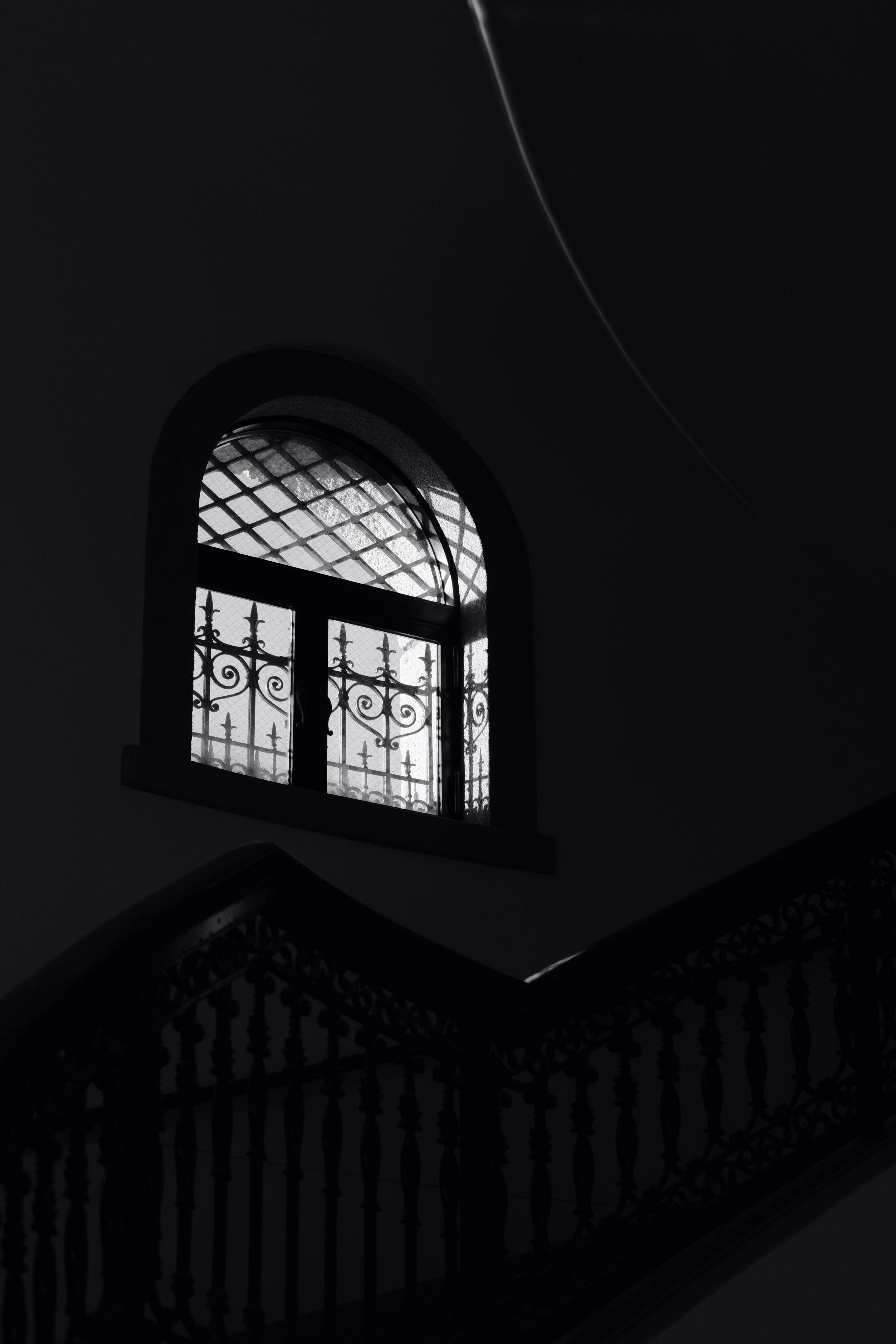 Grayscale Photography of a Window Near Stairs with Wooden Handrails ...