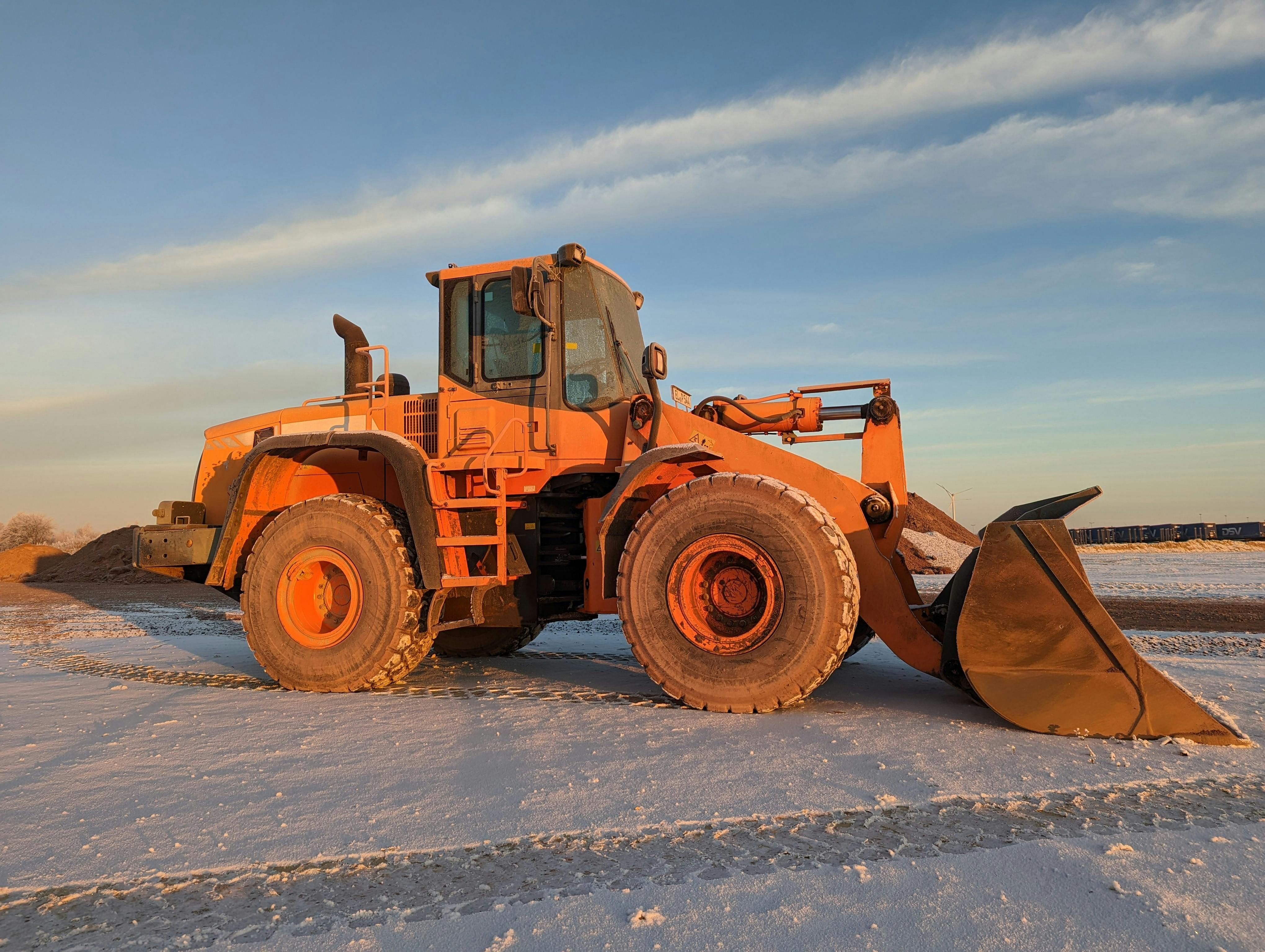 Loader parked on Snow Covered Ground · Free Stock Photo