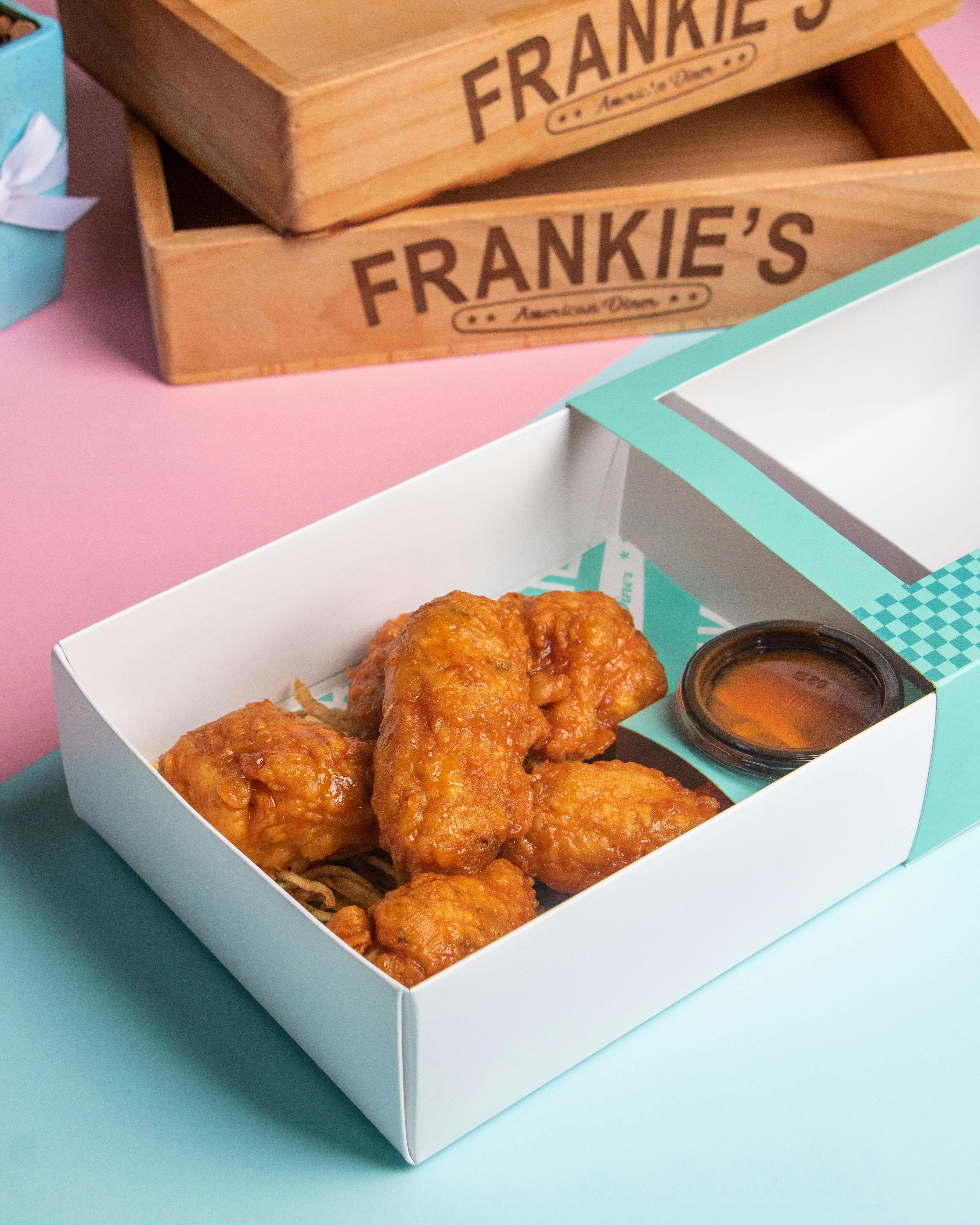 Frankie's chicken box with chicken wings and sauce · Free Stock Photo