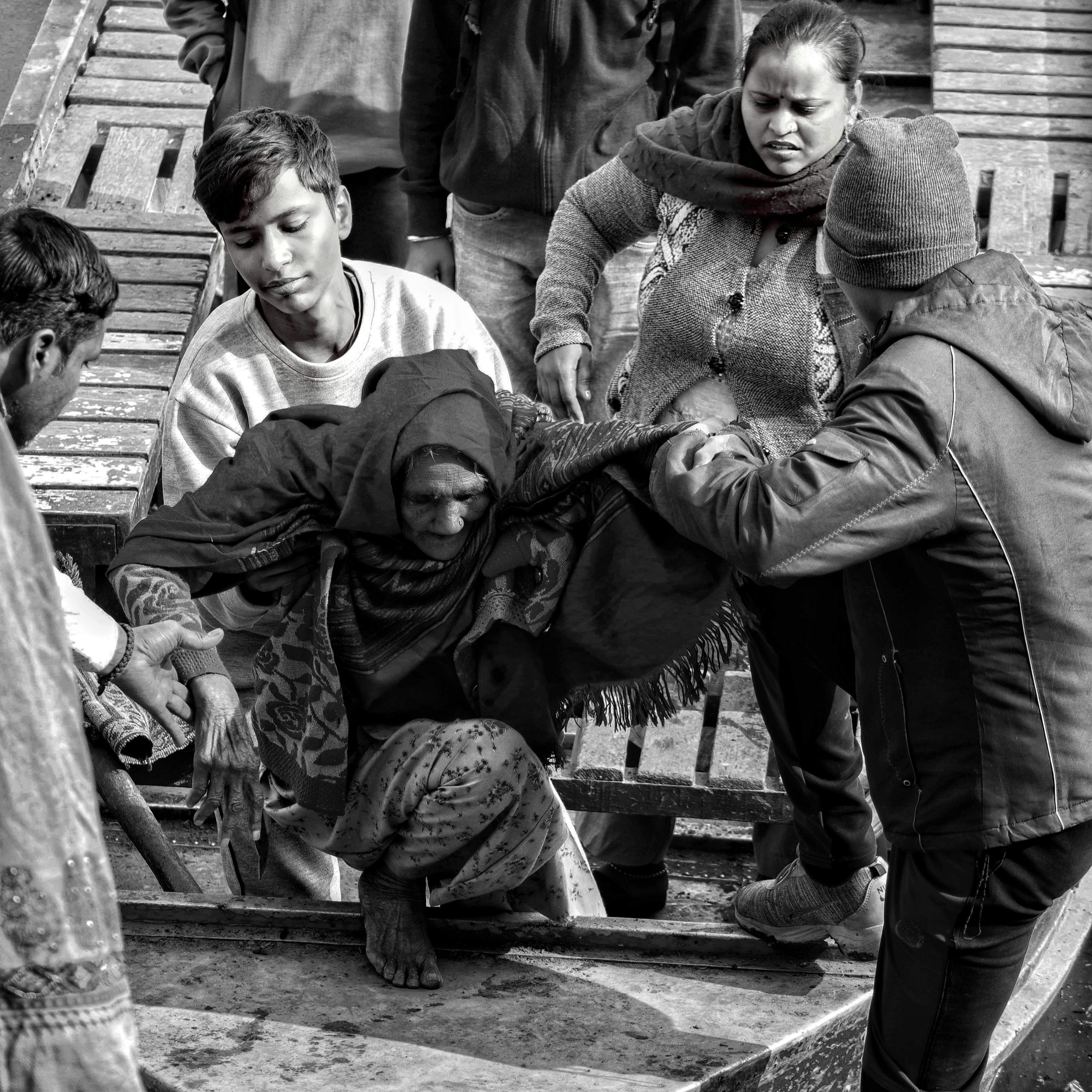 People Helping Elderly Woman with Ritual Ablution · Free Stock Photo