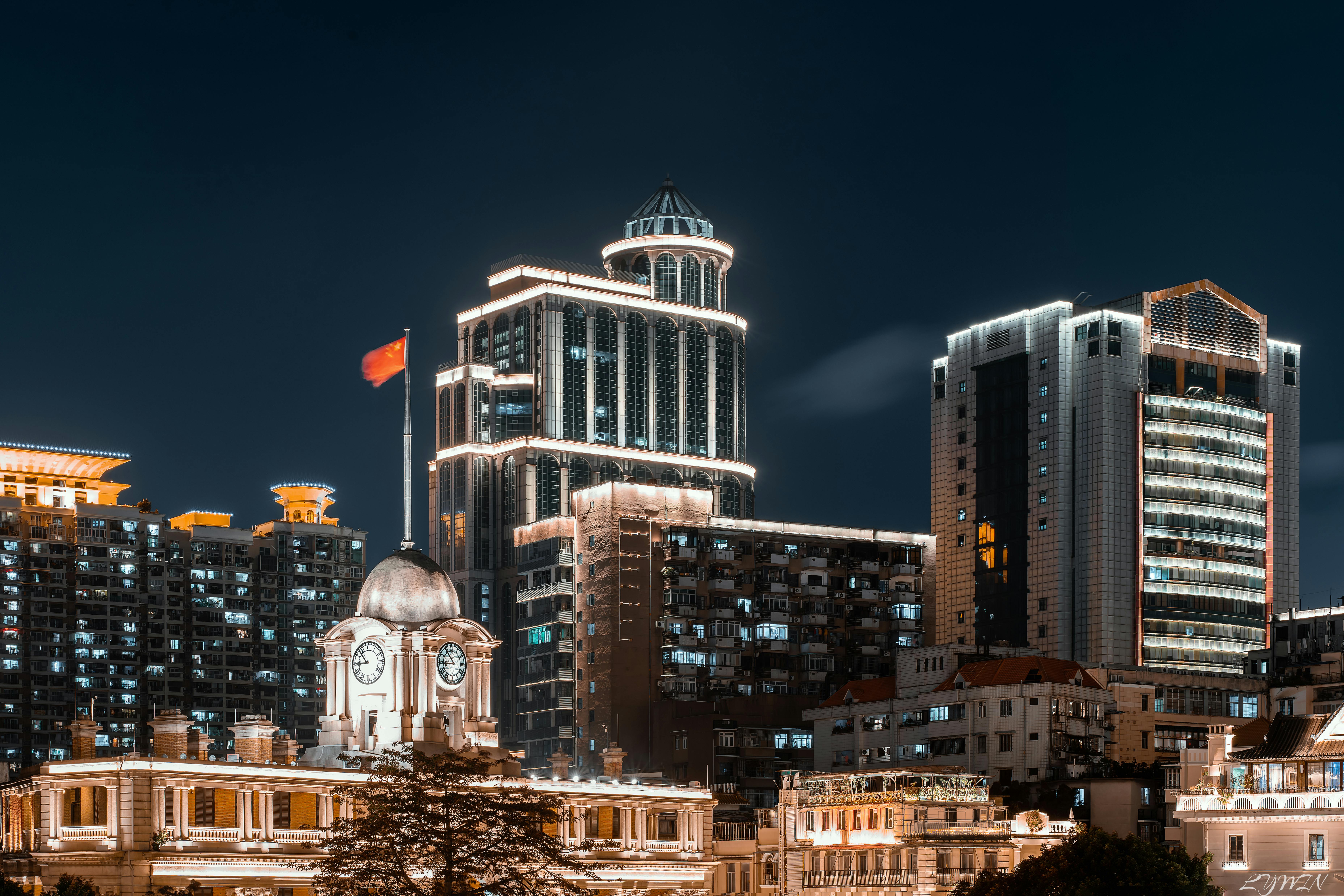 City Buildings with Lights During Night Time · Free Stock Photo