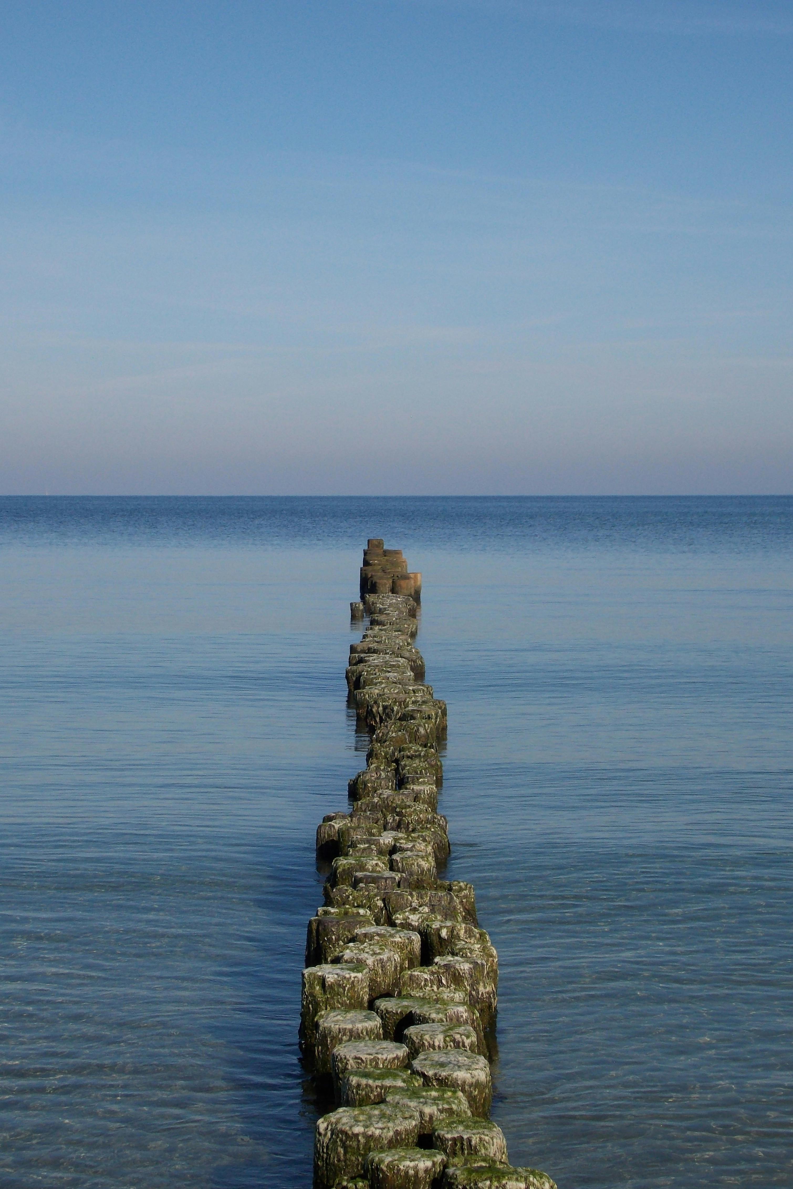Concrete Breakwaters along Path Leading to Light · Free Stock Photo