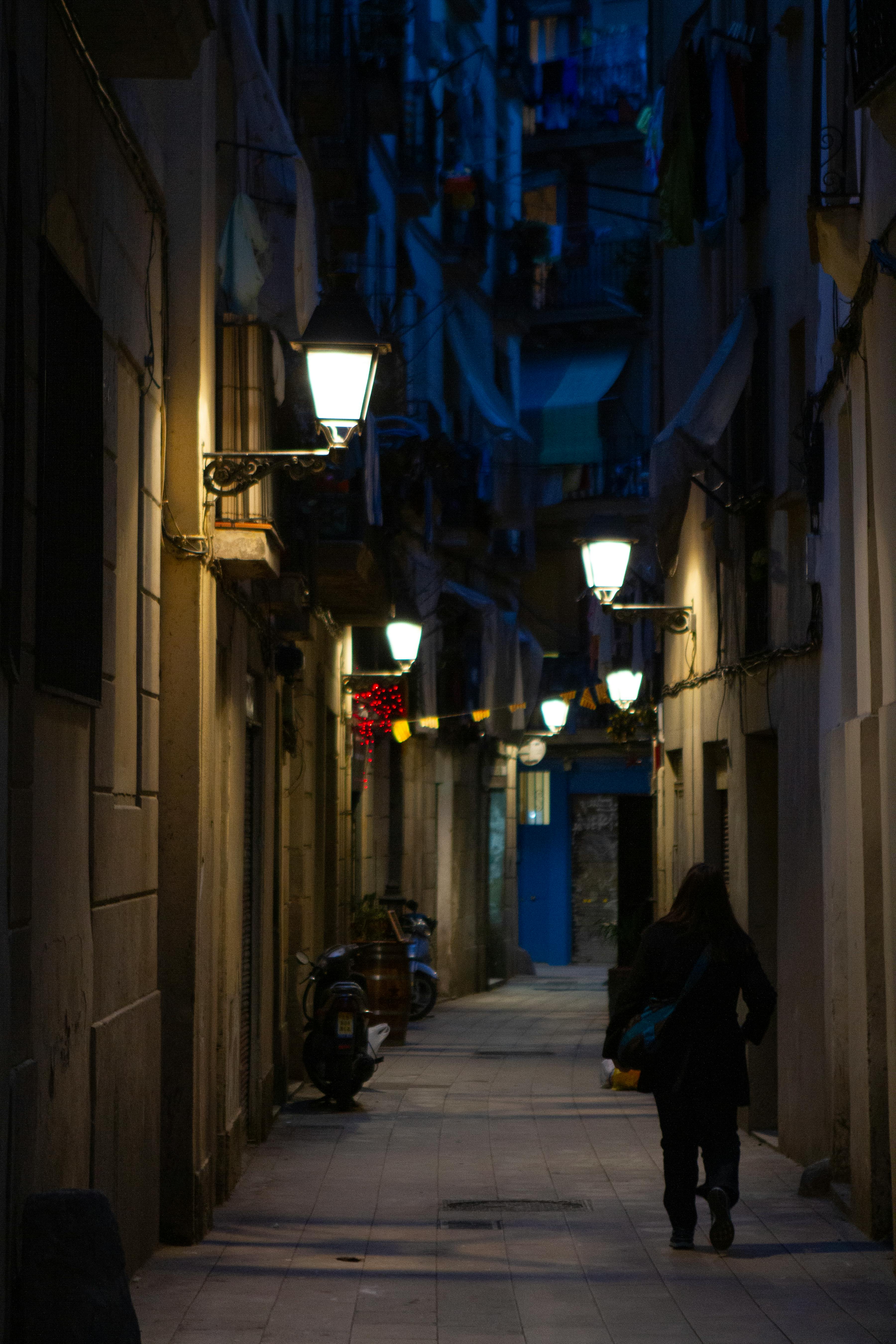 Person Walking between Buildings in Narrow Alley at Night · Free Stock ...