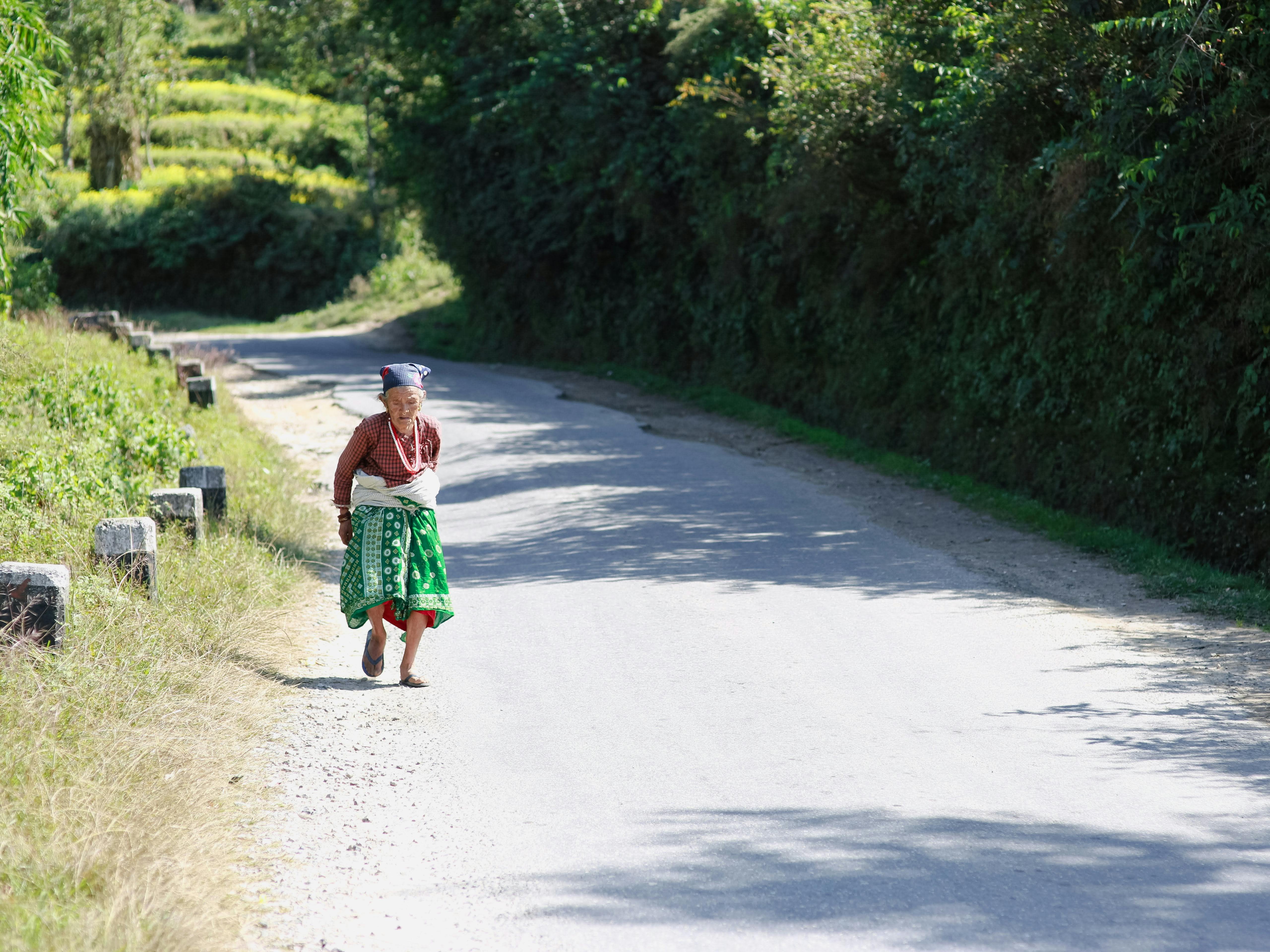 Elderly Woman Walking Uphill · Free Stock Photo