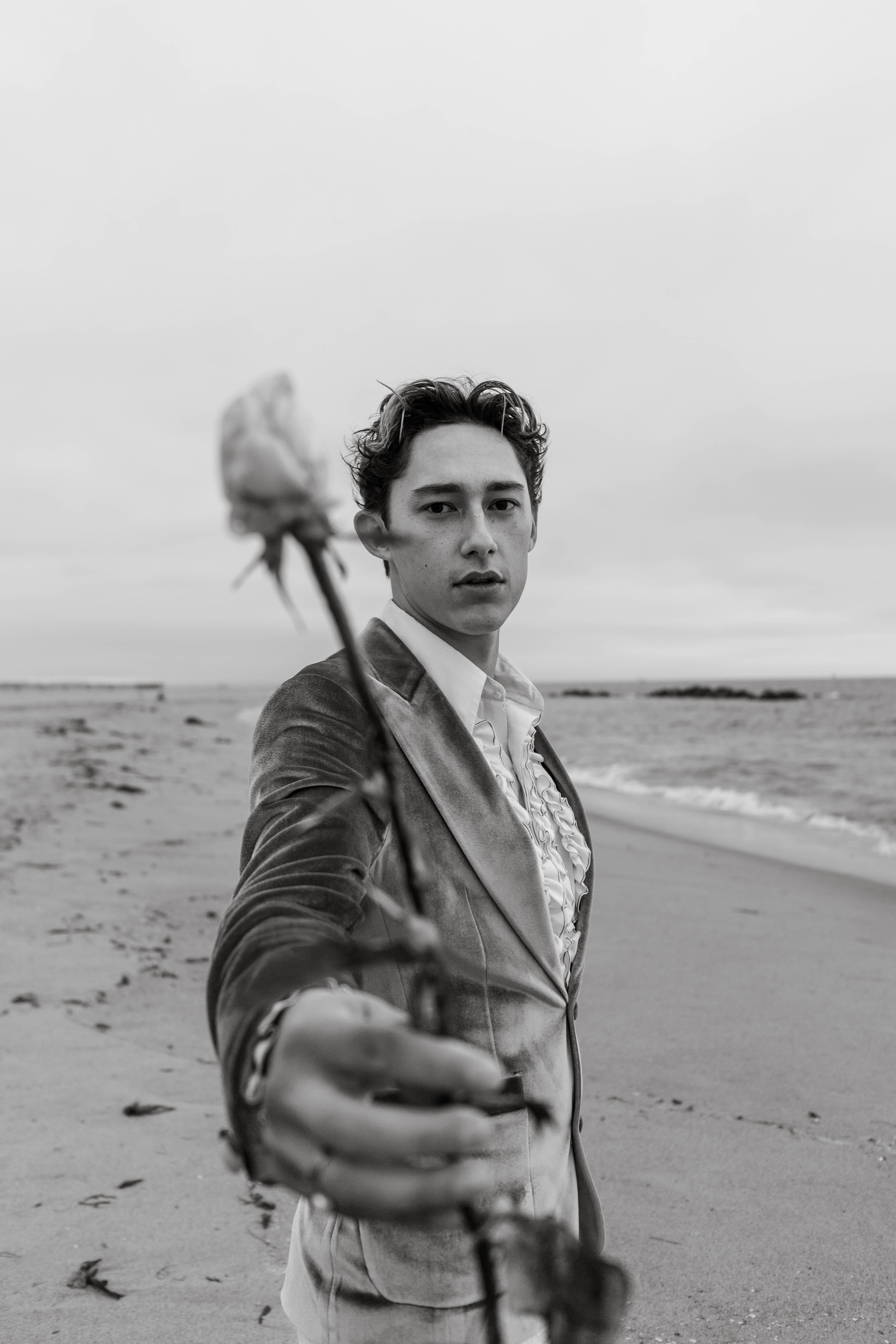 Man with Flower on Beach in Black and White · Free Stock Photo