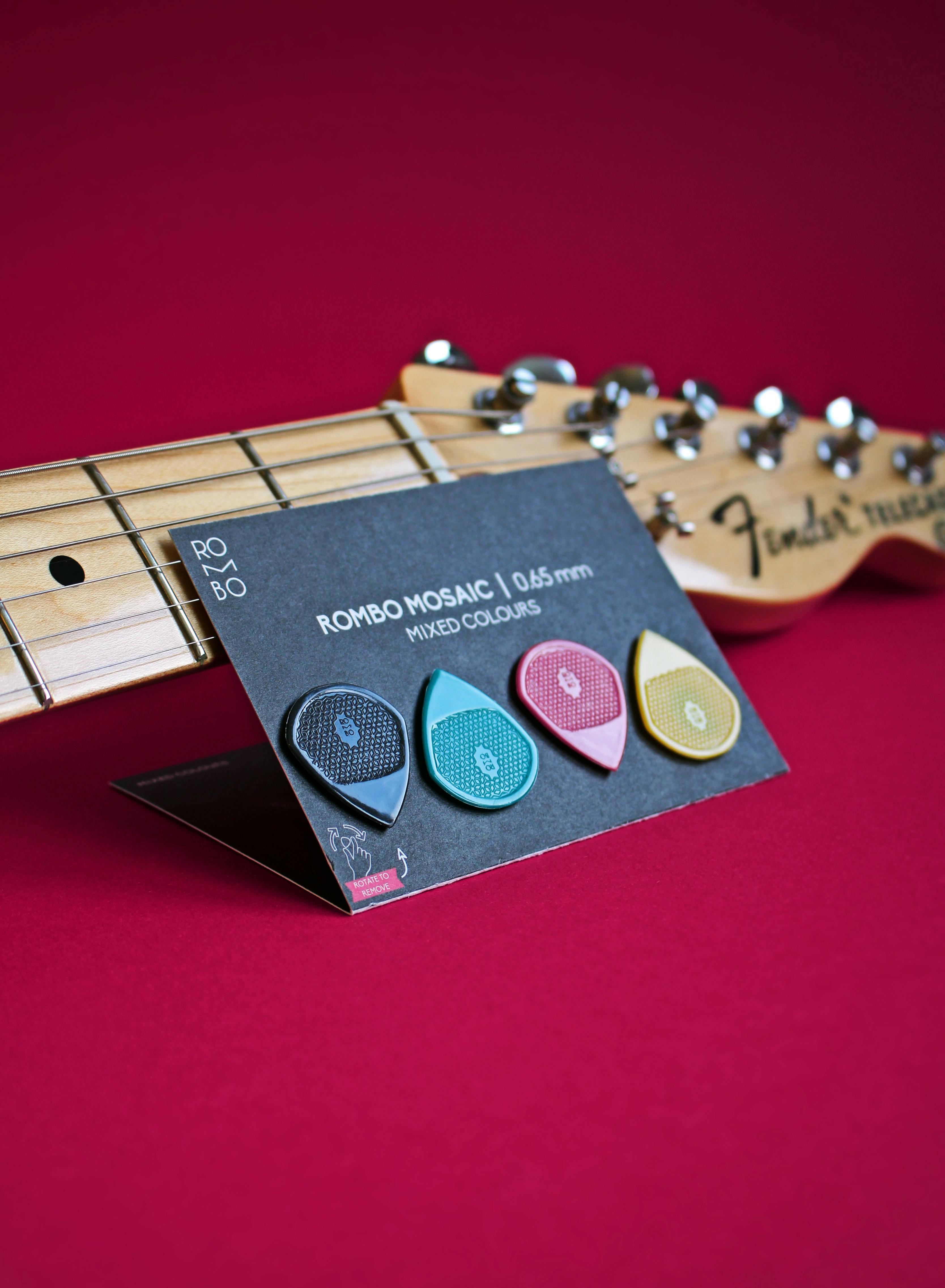 Small pointy guitar pick and electric guitar · Free Stock Photo