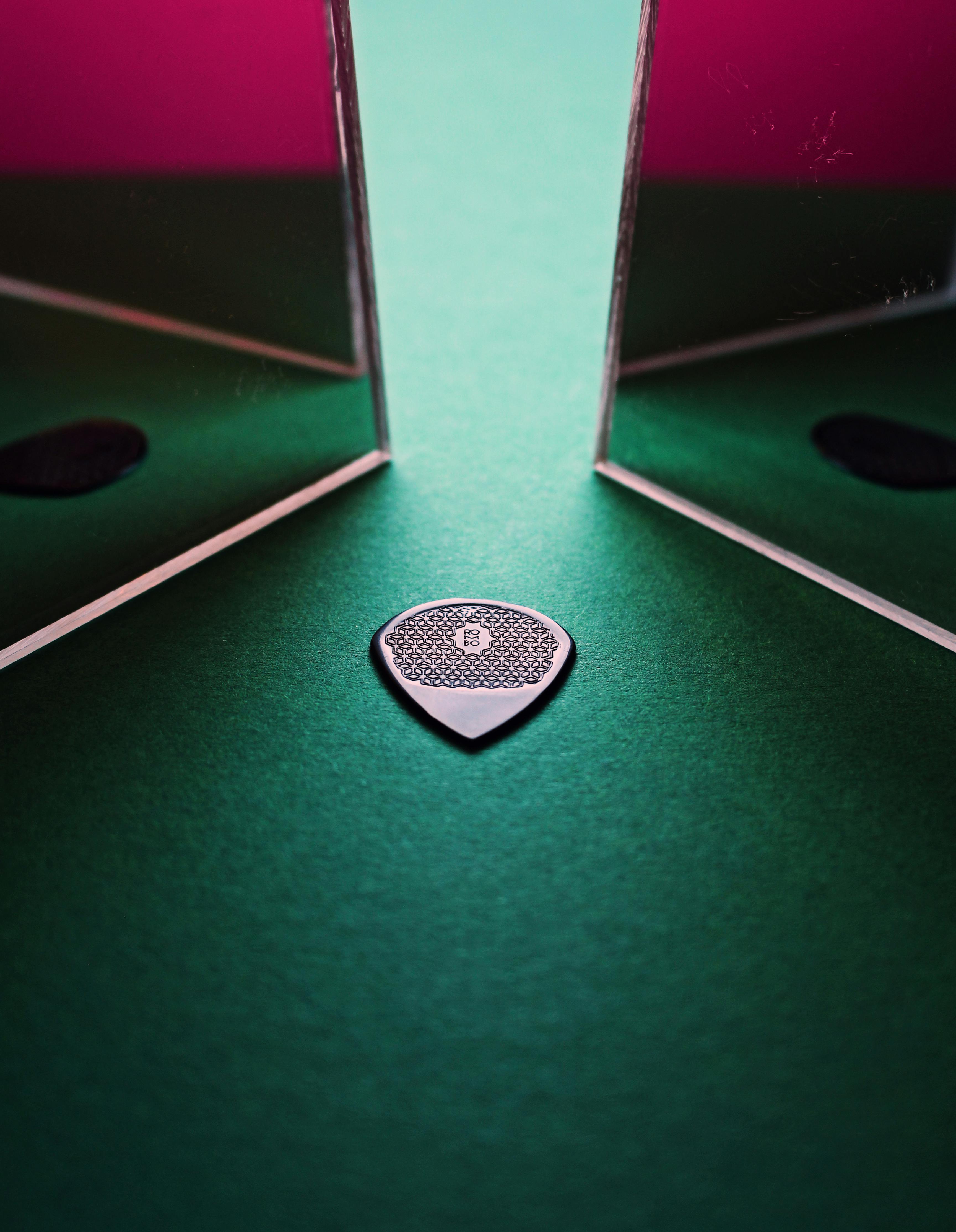 Guitar Pick near Mirrors on Green Background · Free Stock Photo