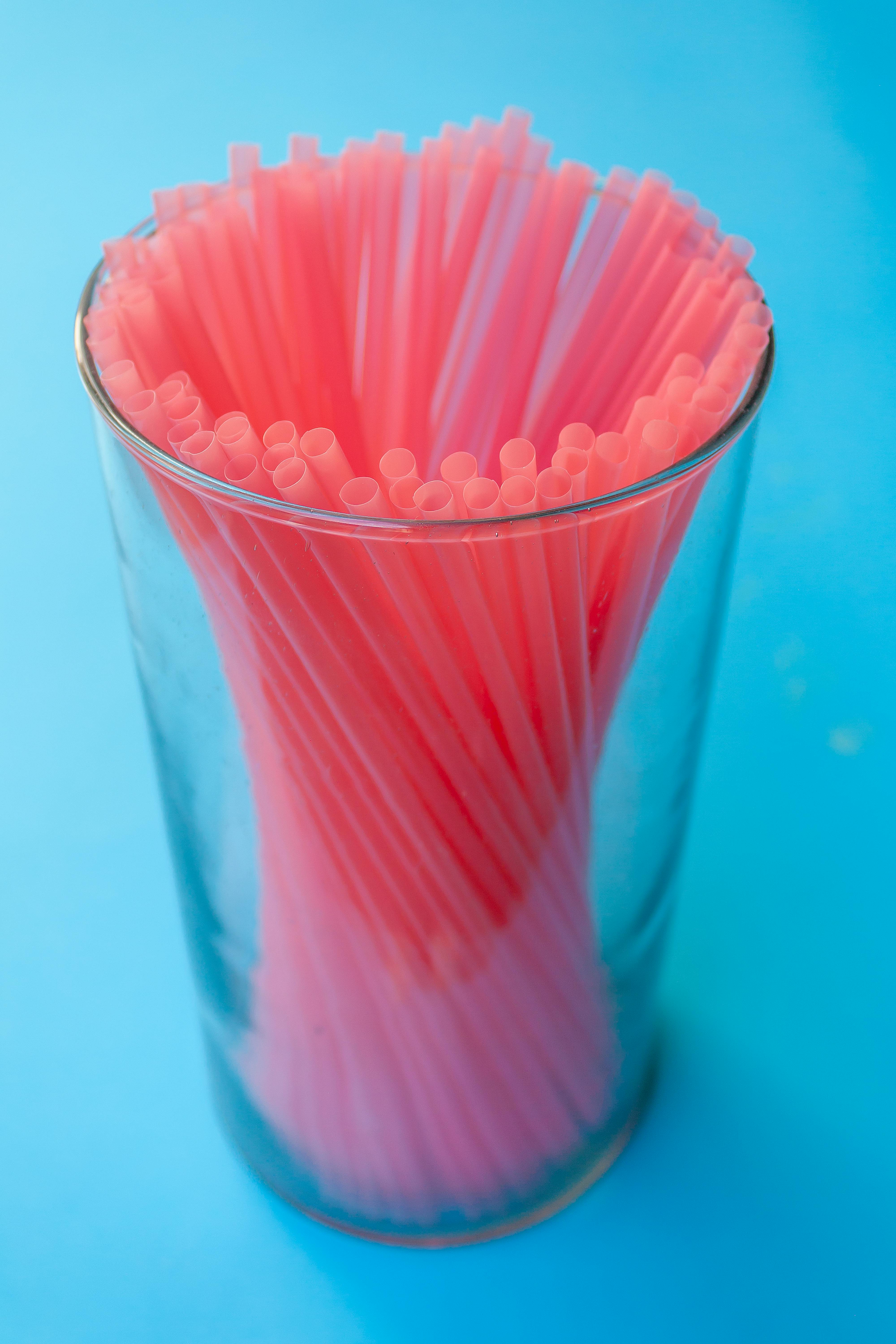 A glass filled with pink plastic straws · Free Stock Photo