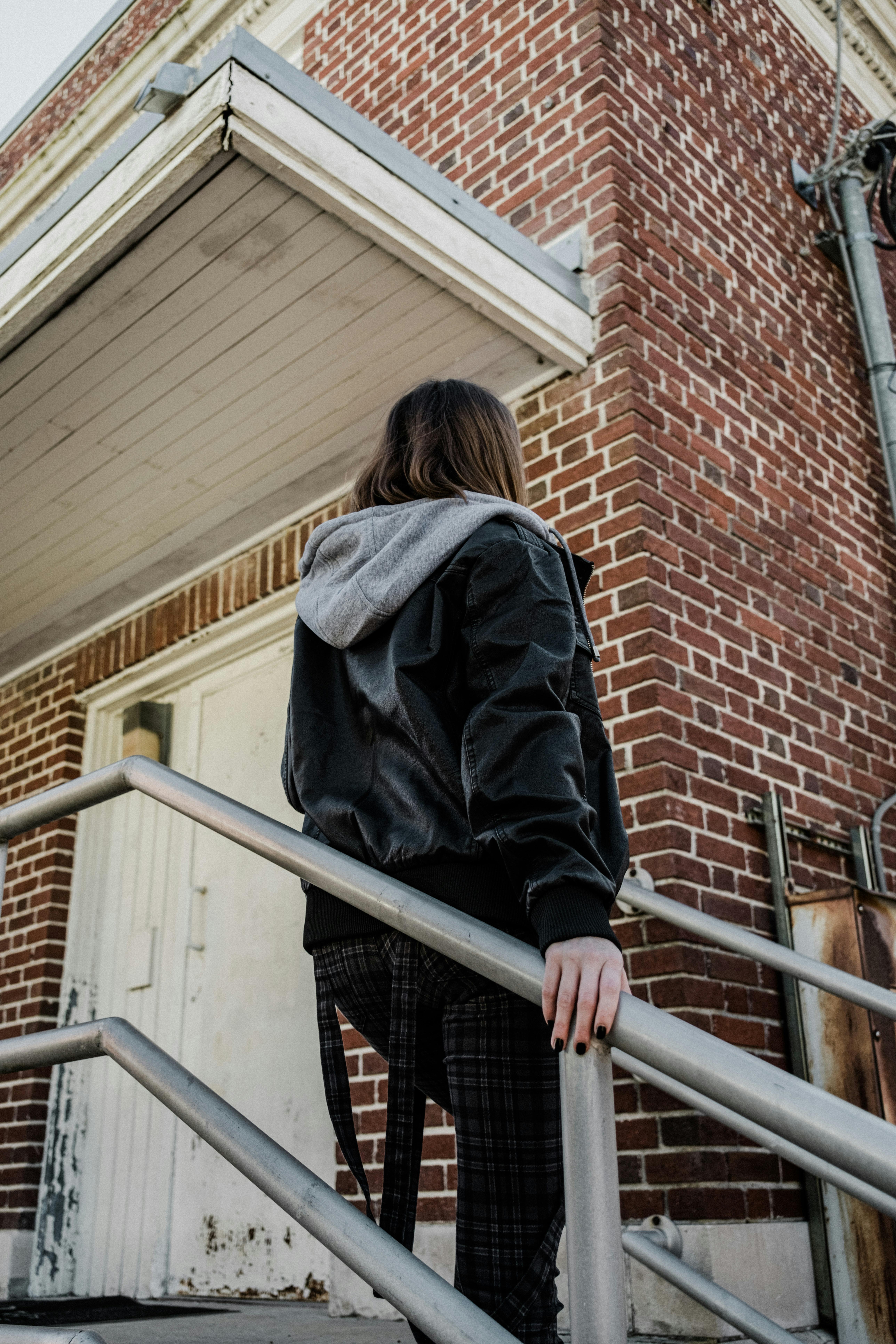 Back View of a Woman Standing on the Stairs · Free Stock Photo