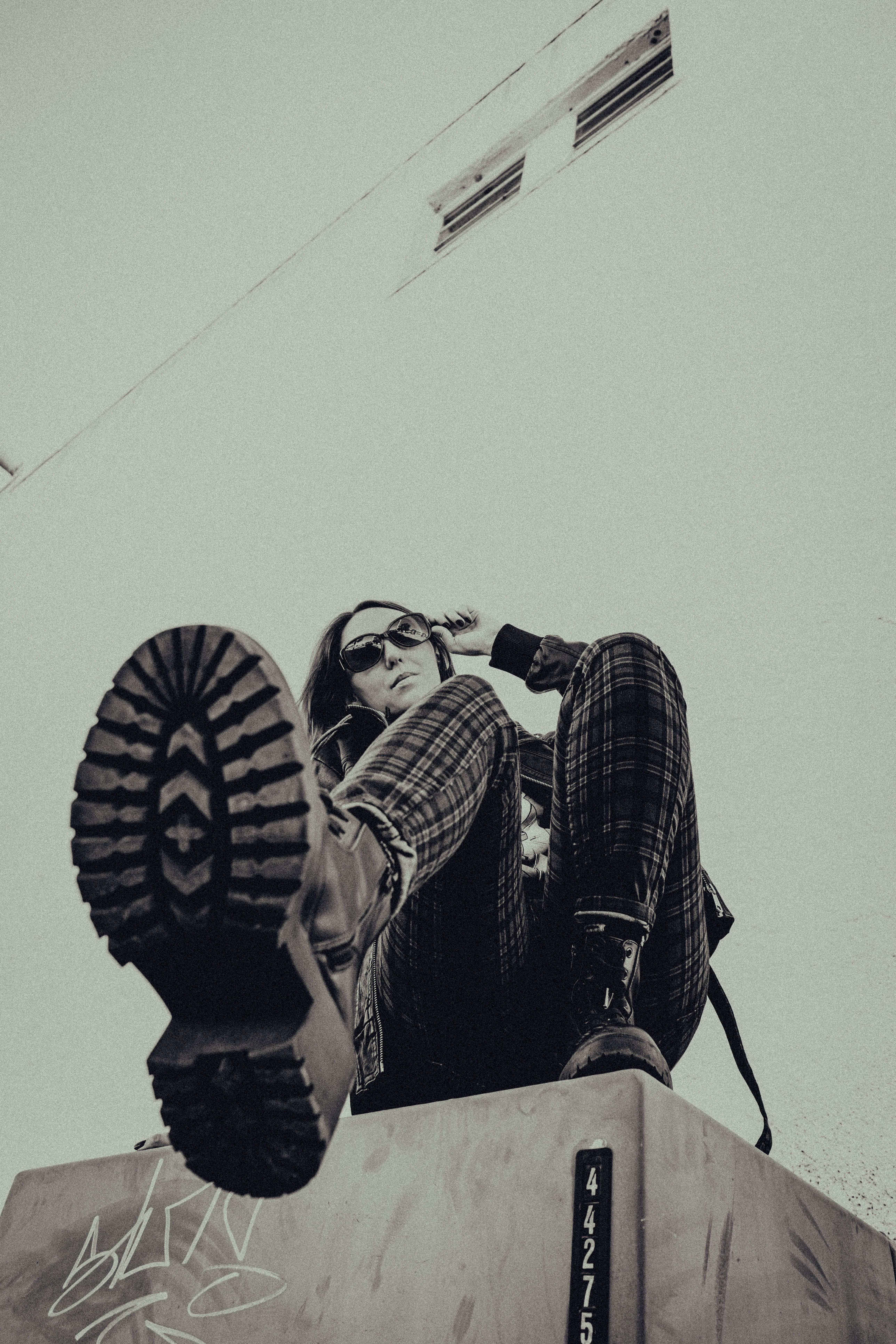 Grayscale Photo of a Woman Posing on a Platform · Free Stock Photo