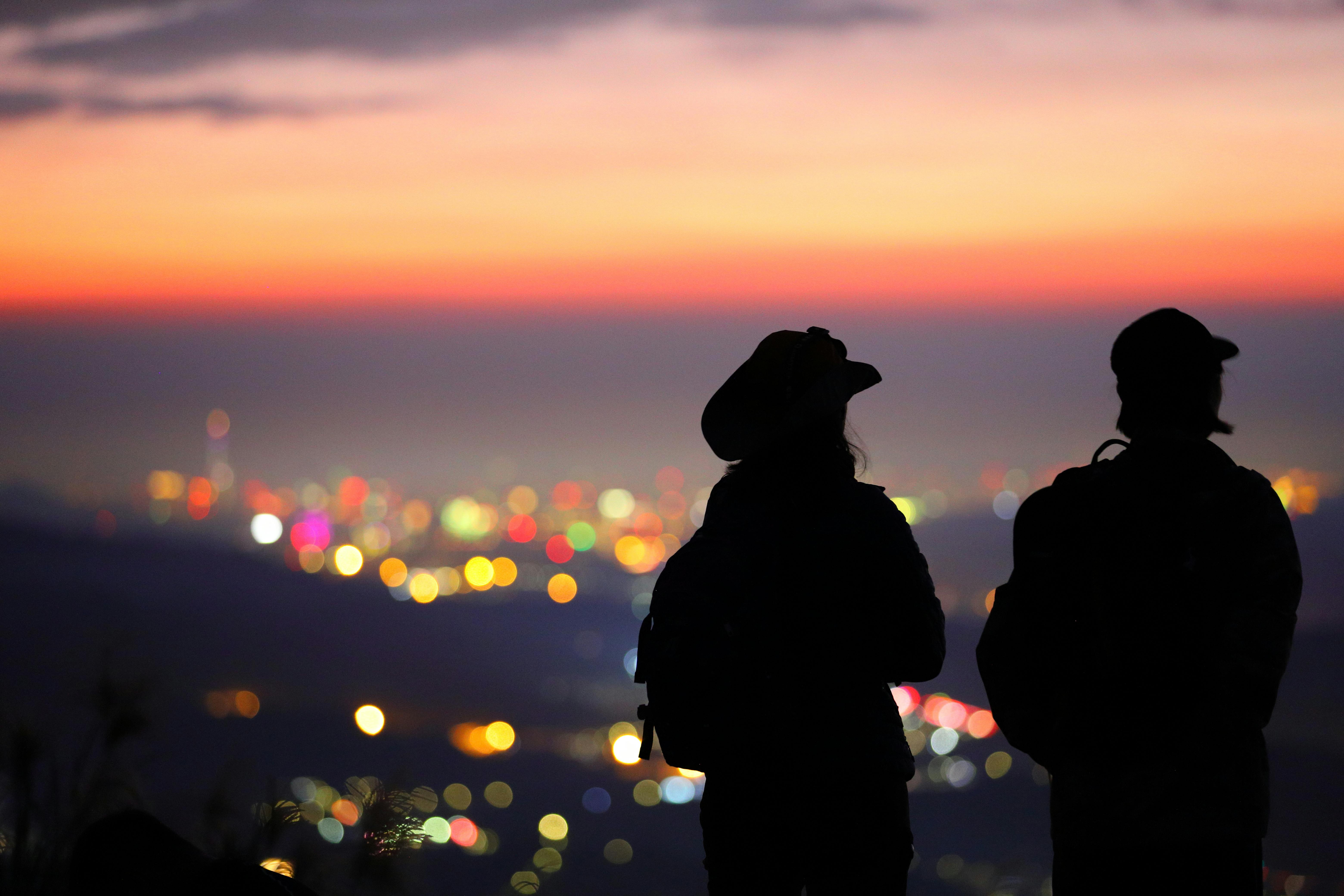 Silhouette of People Overlooking the Bright City · Free Stock Photo