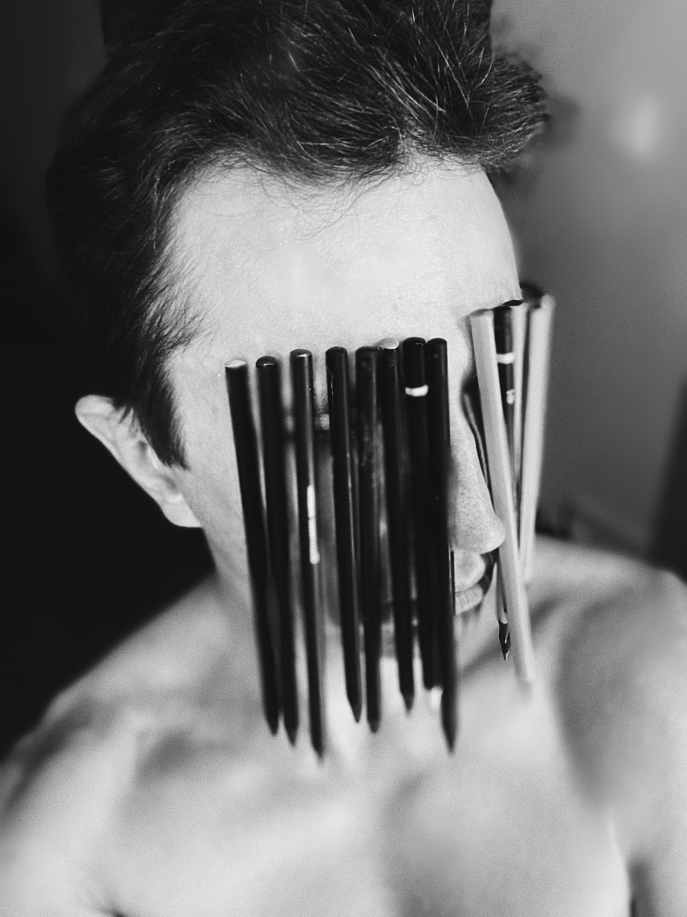 Black and White Photo of Man with Pencils on his Face · Free Stock Photo