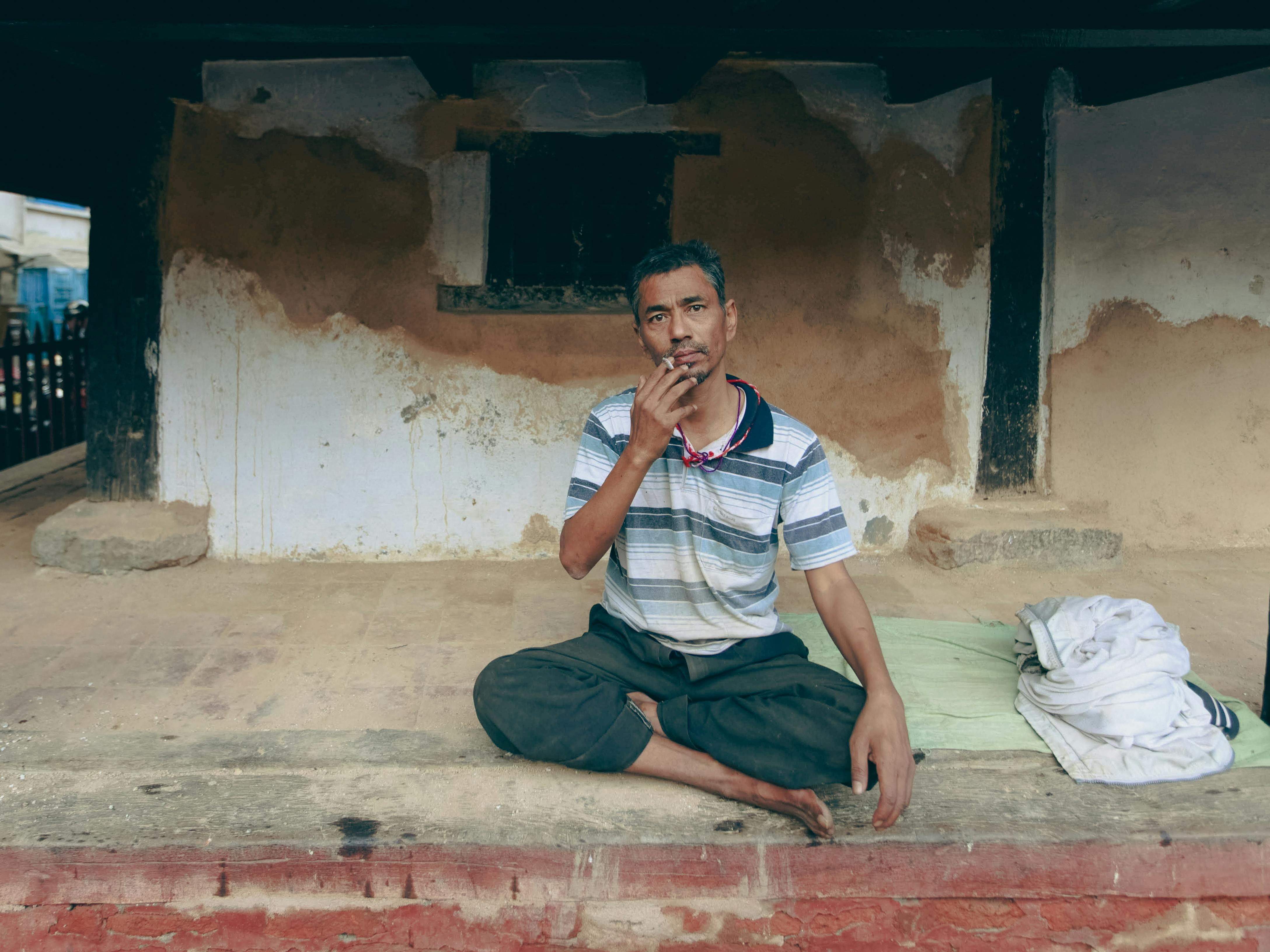 Man Sitting Cross Legged on Rock by Waterfall and Meditating · Free ...