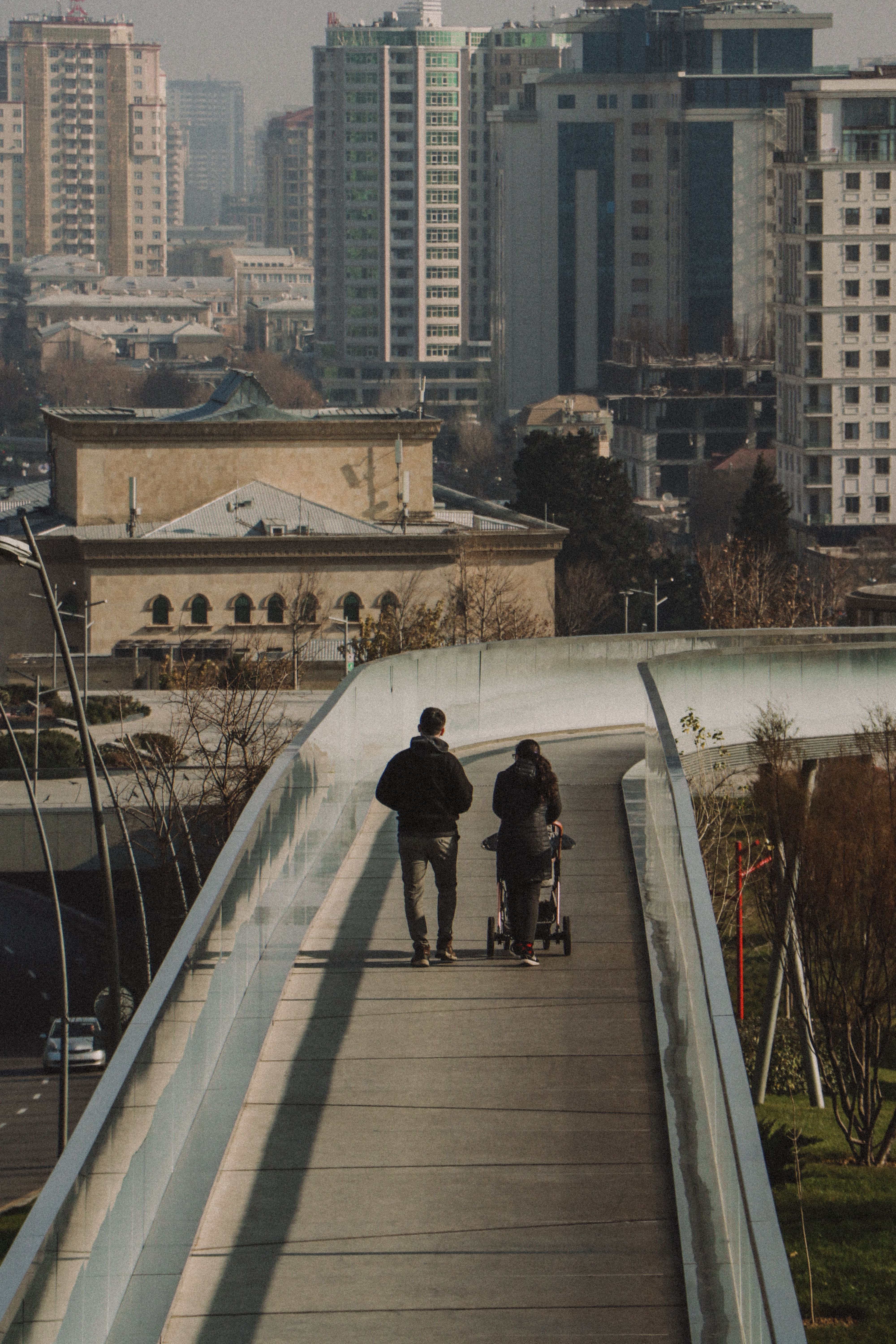 Aerial View of Man and Woman Walking on a Footbridge in City · Free ...