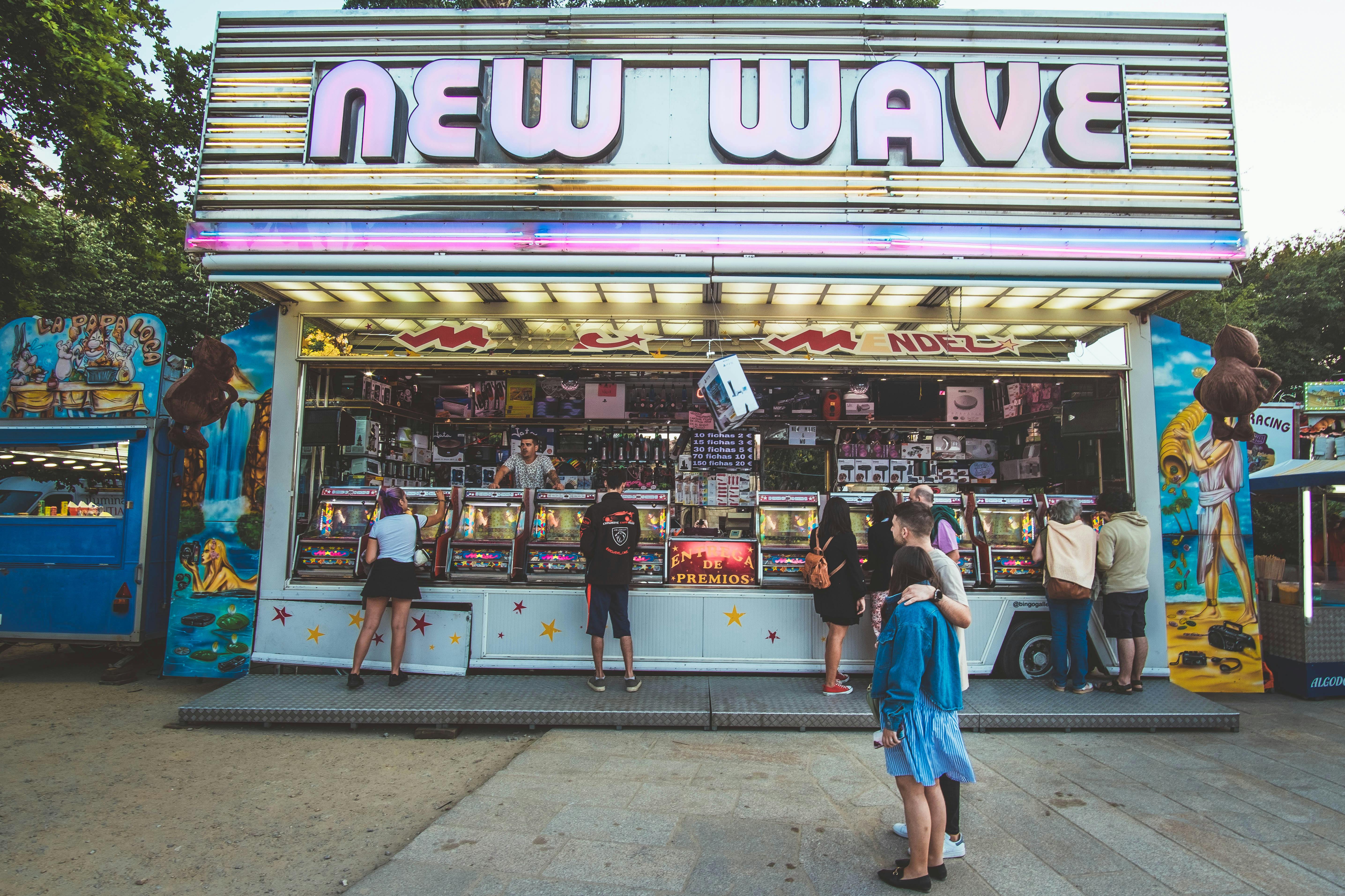 People Buying Snacks from a Bar at a Fairground · Free Stock Photo