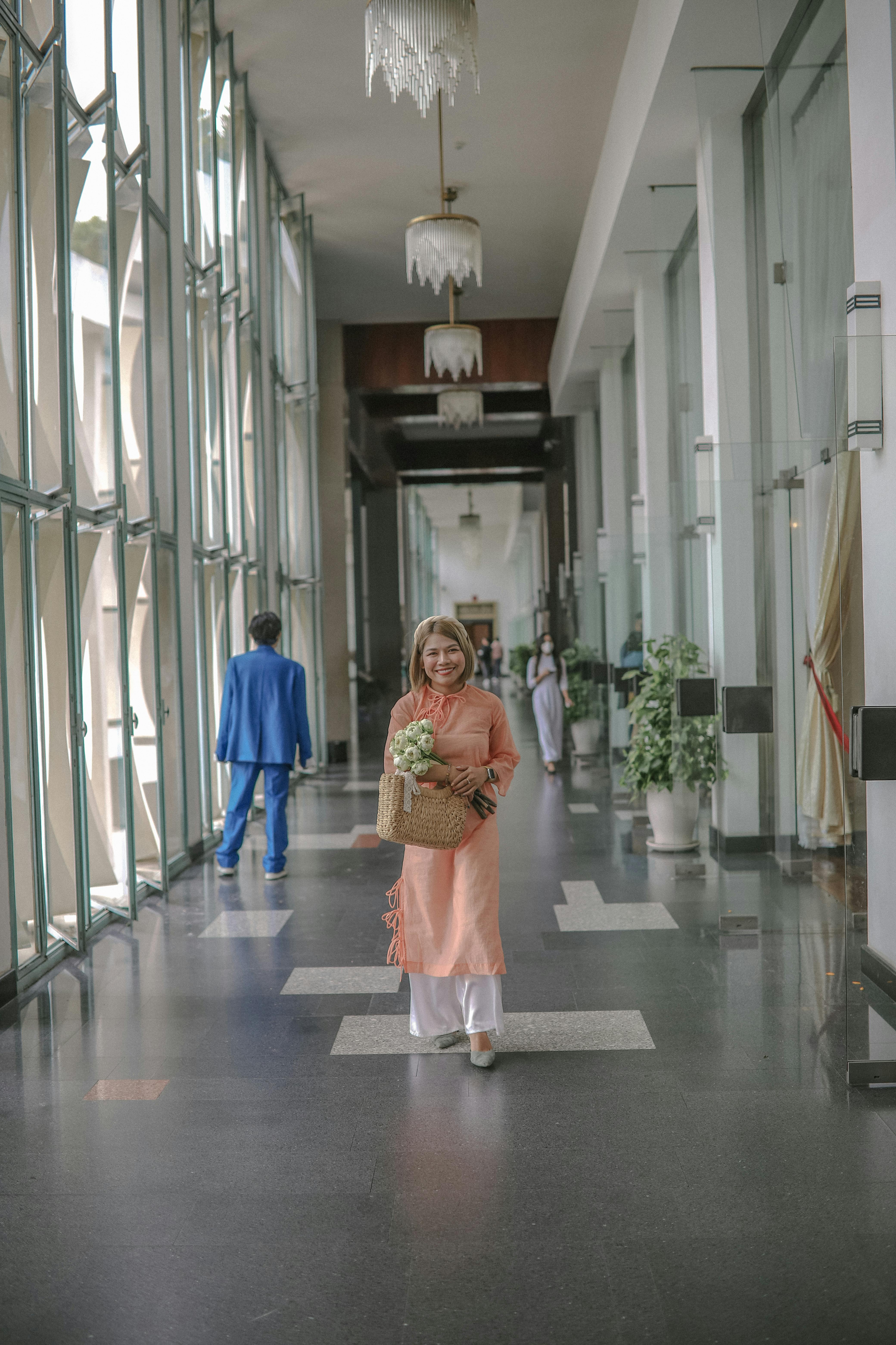 Woman Walking on a Hallway · Free Stock Photo