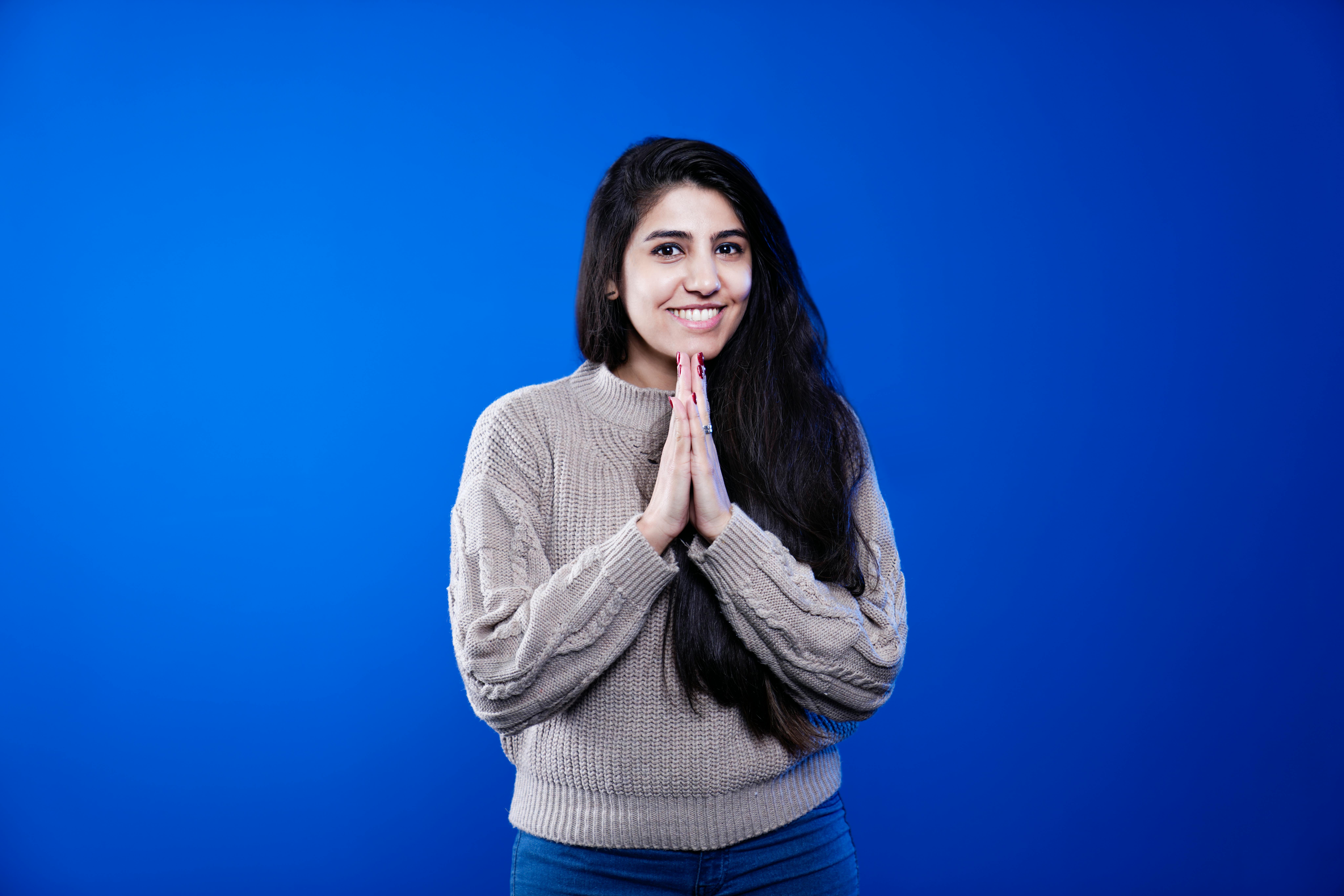 Woman in Blue Background Praying · Free Stock Photo