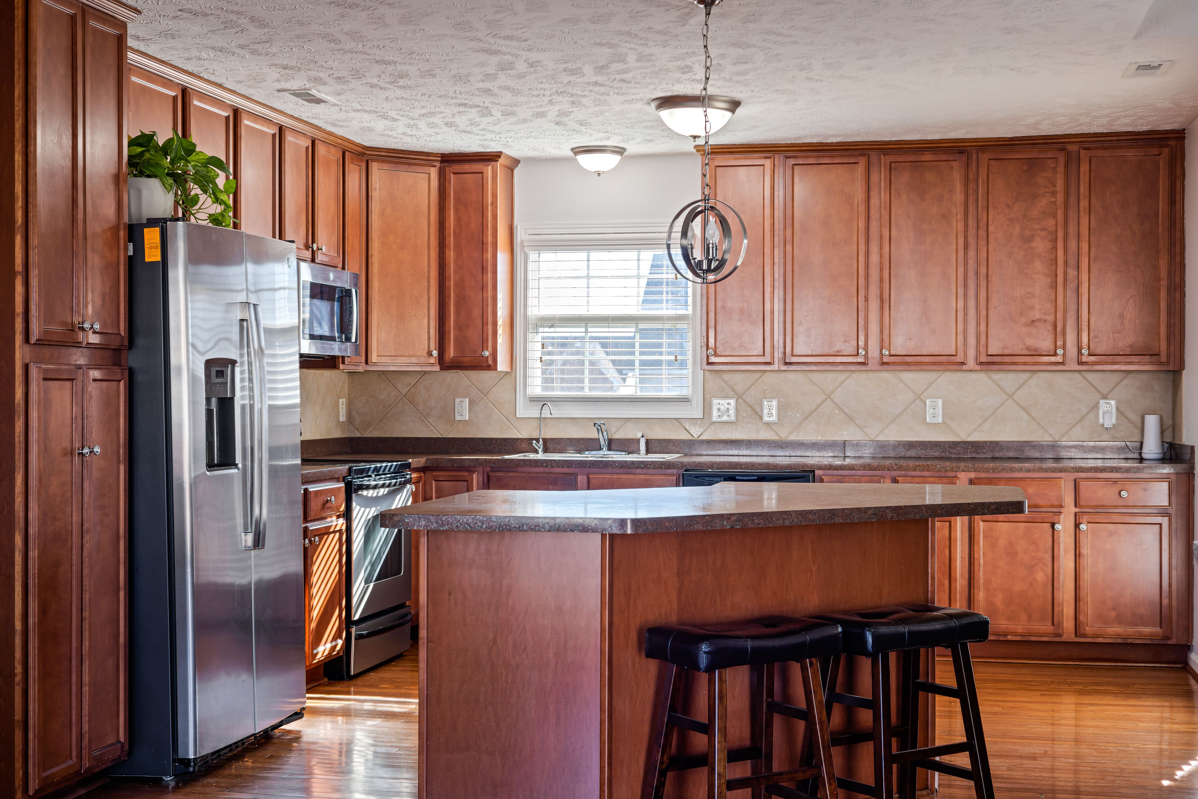 Wooden Kitchen Cabinets And Marble Top Counters In Kitchen · Free Stock ...