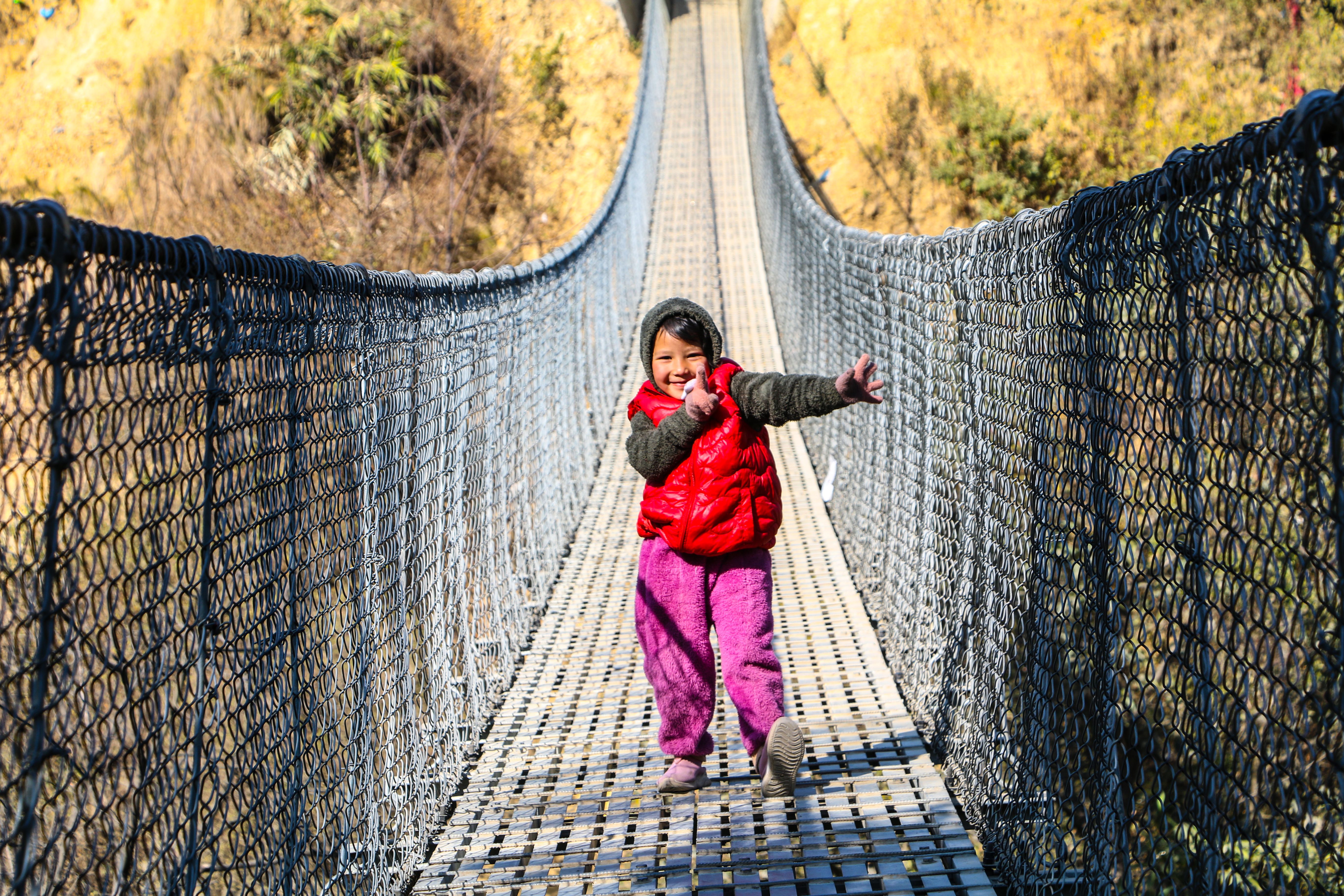 Little Girl Posing on a Hanging Bridge · Free Stock Photo