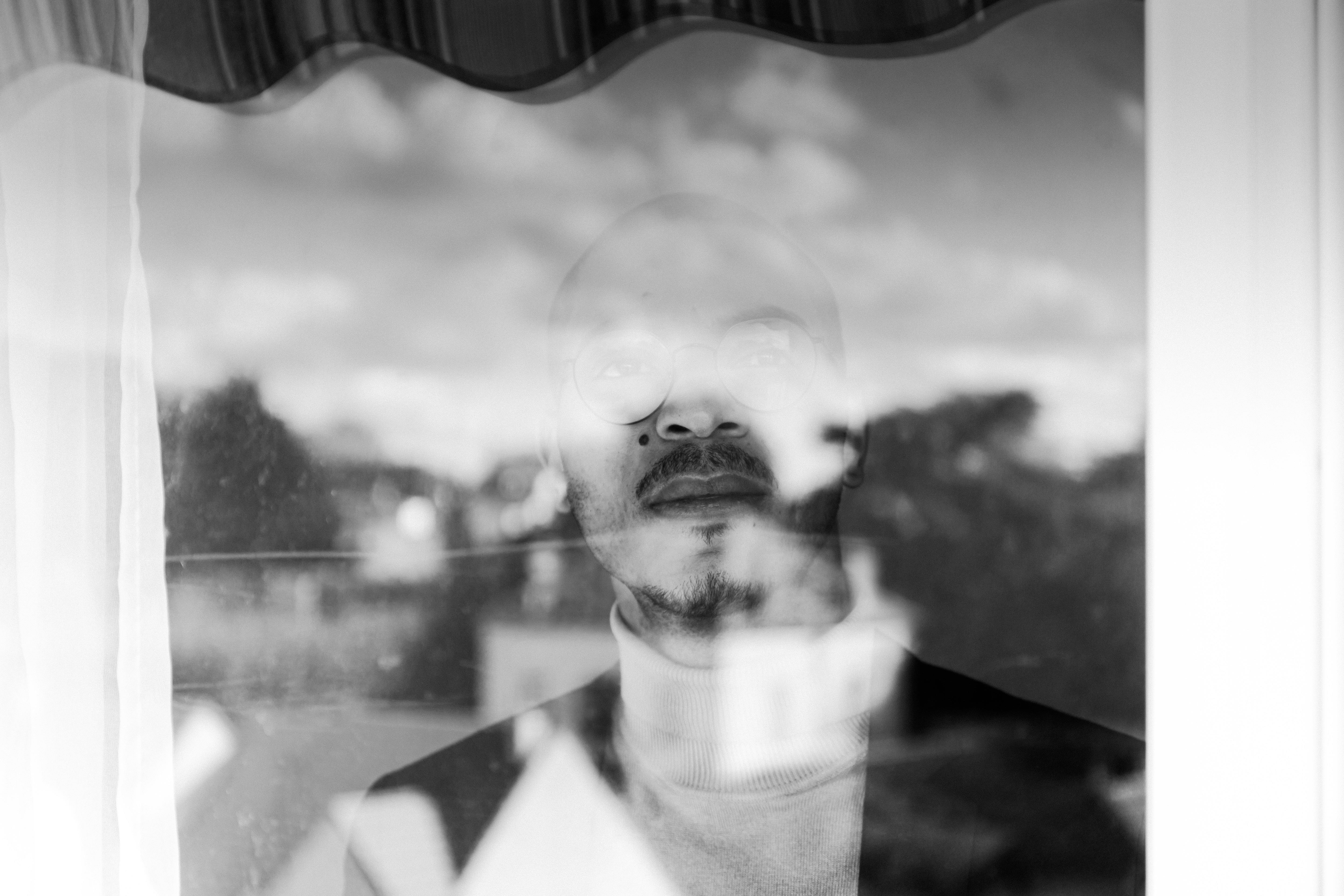 Man Wearing Eyeglasses Behind the Glass Window · Free Stock Photo