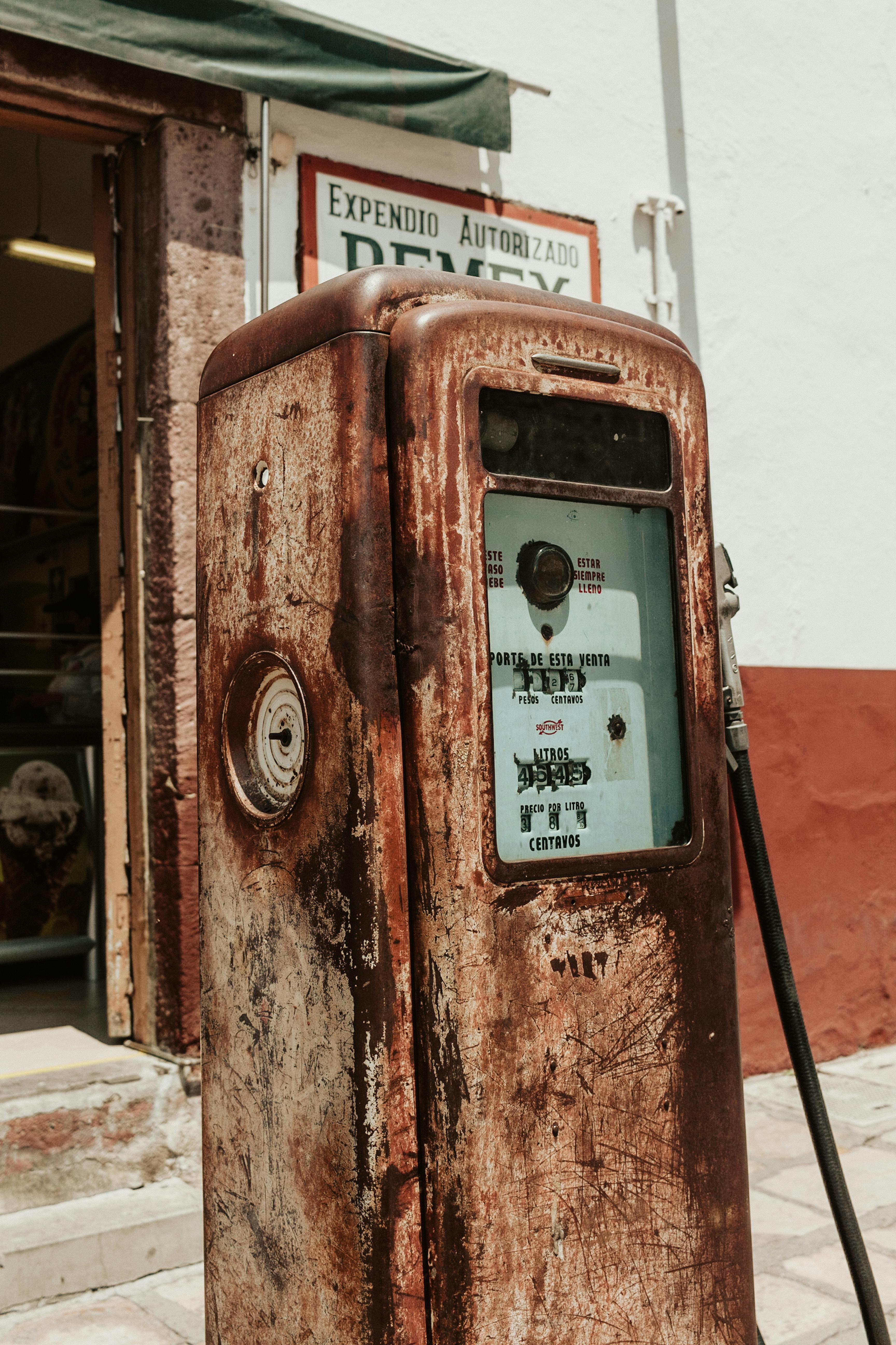 Close-up of an Old, Rusty Gas Pump at a Gas Station · Free Stock Photo