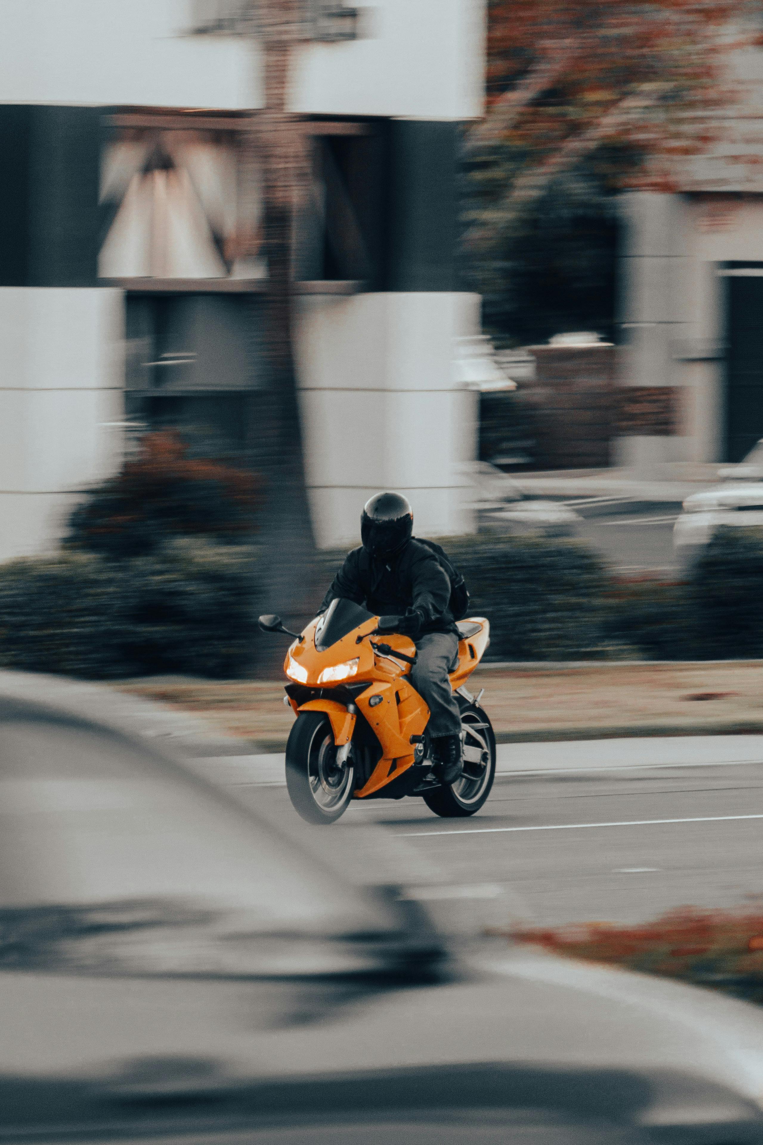 Photo of Person Riding Motorcycle on Road Between Trees · Free Stock Photo