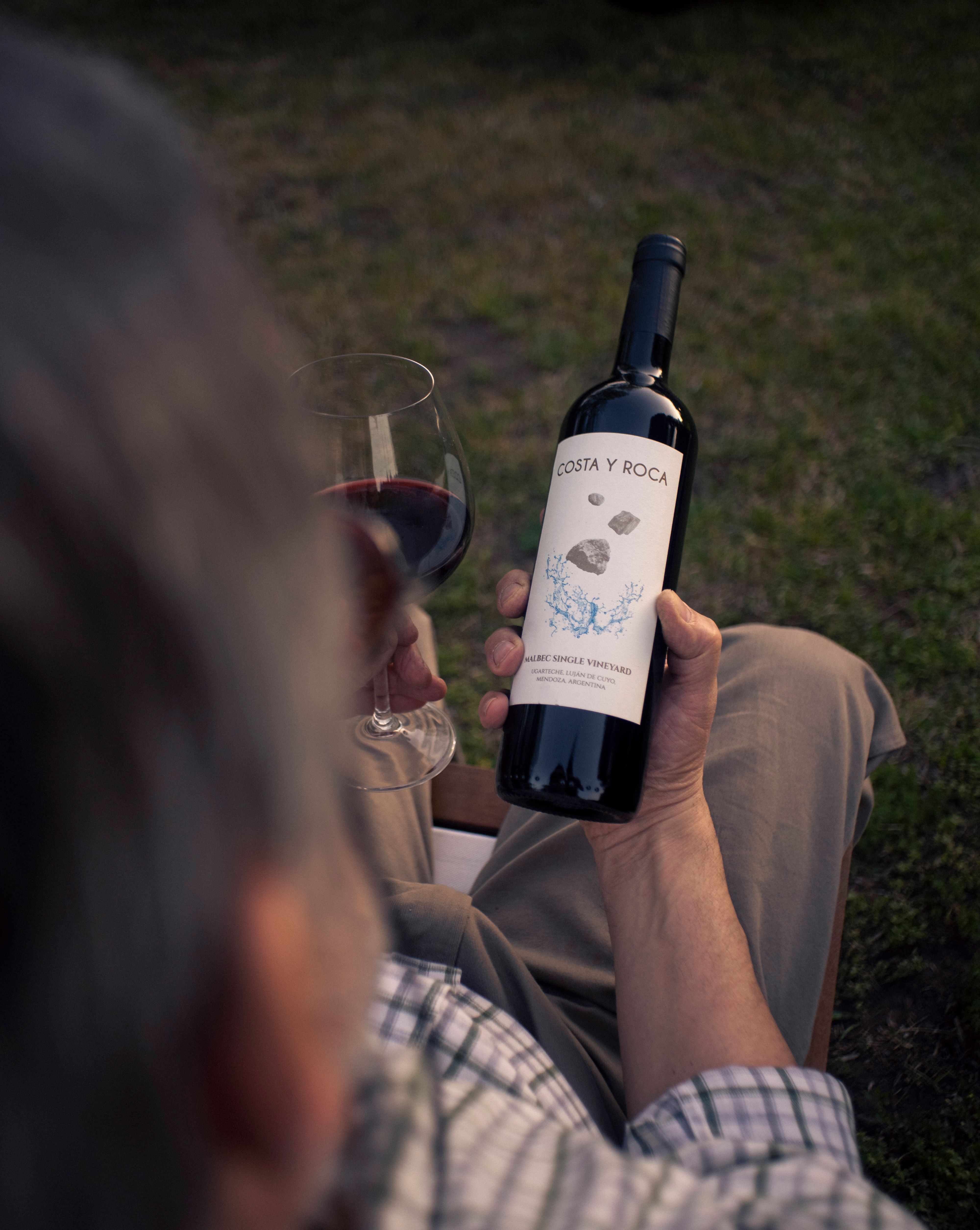 Person Holding a Red Wine · Free Stock Photo