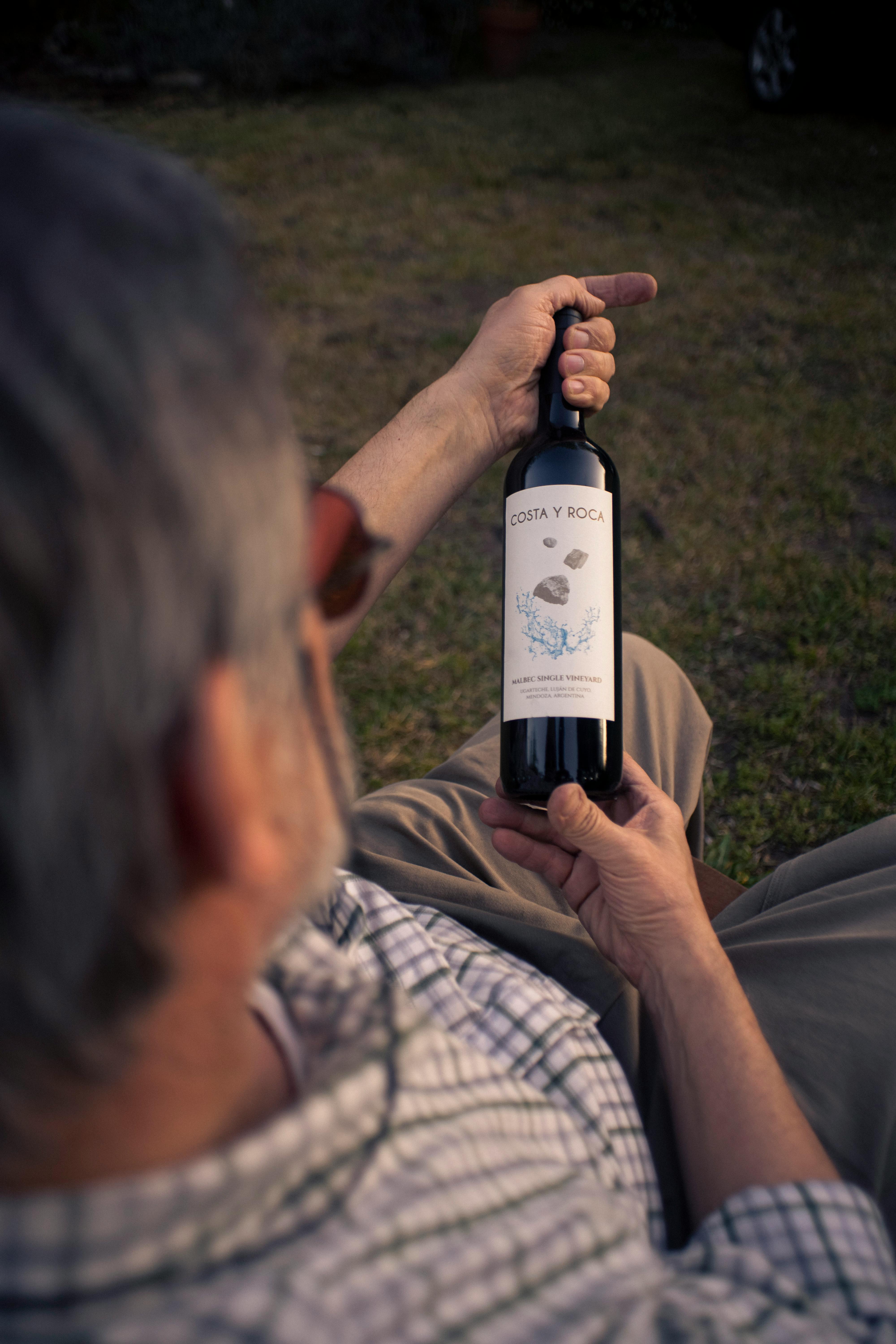 Man Holding Wine Bottle · Free Stock Photo